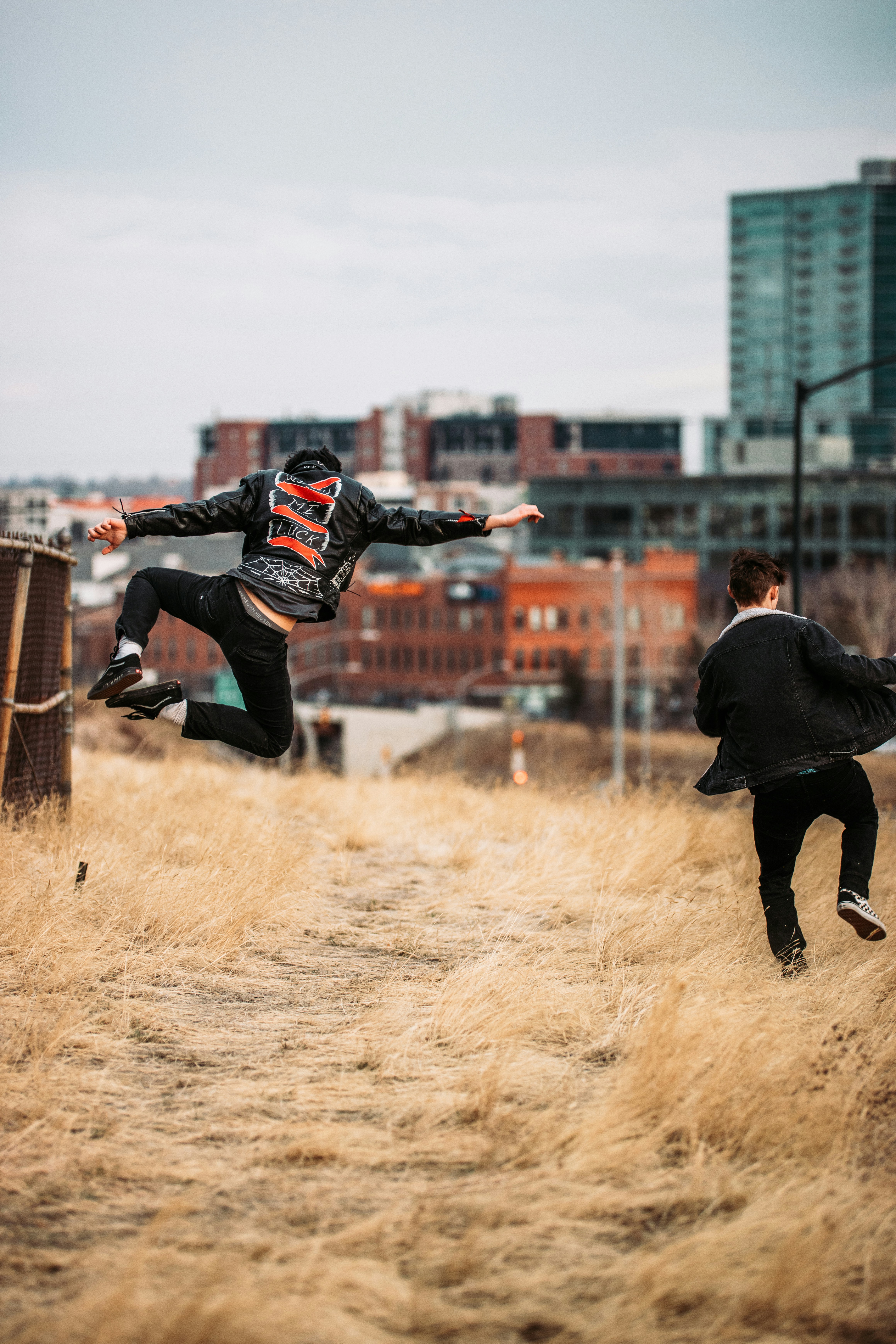 Midair Moment on a Grassland Chase Toward the Cityscape