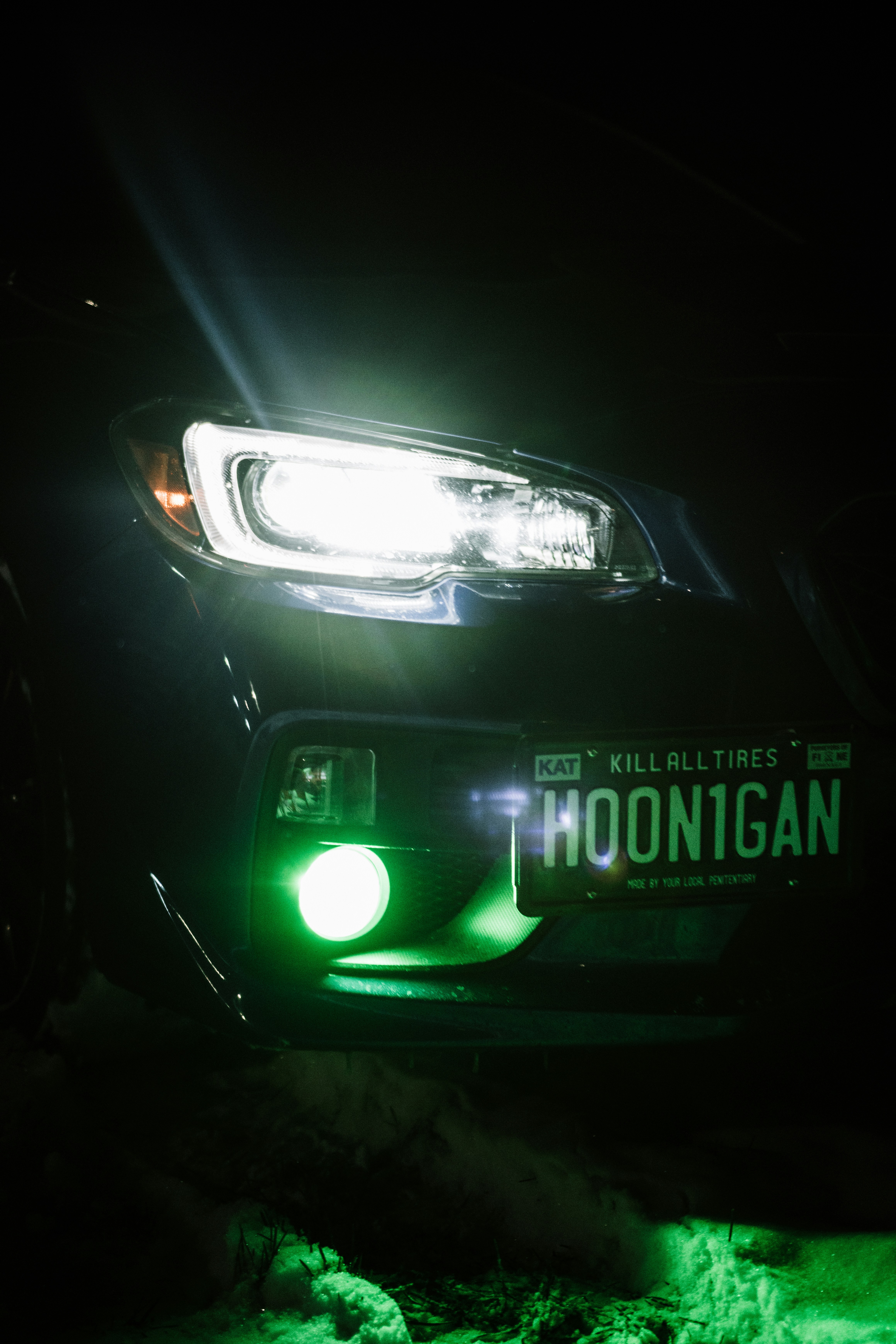 Green glow of the street-tuned front: HOONIGAN under night headlamps