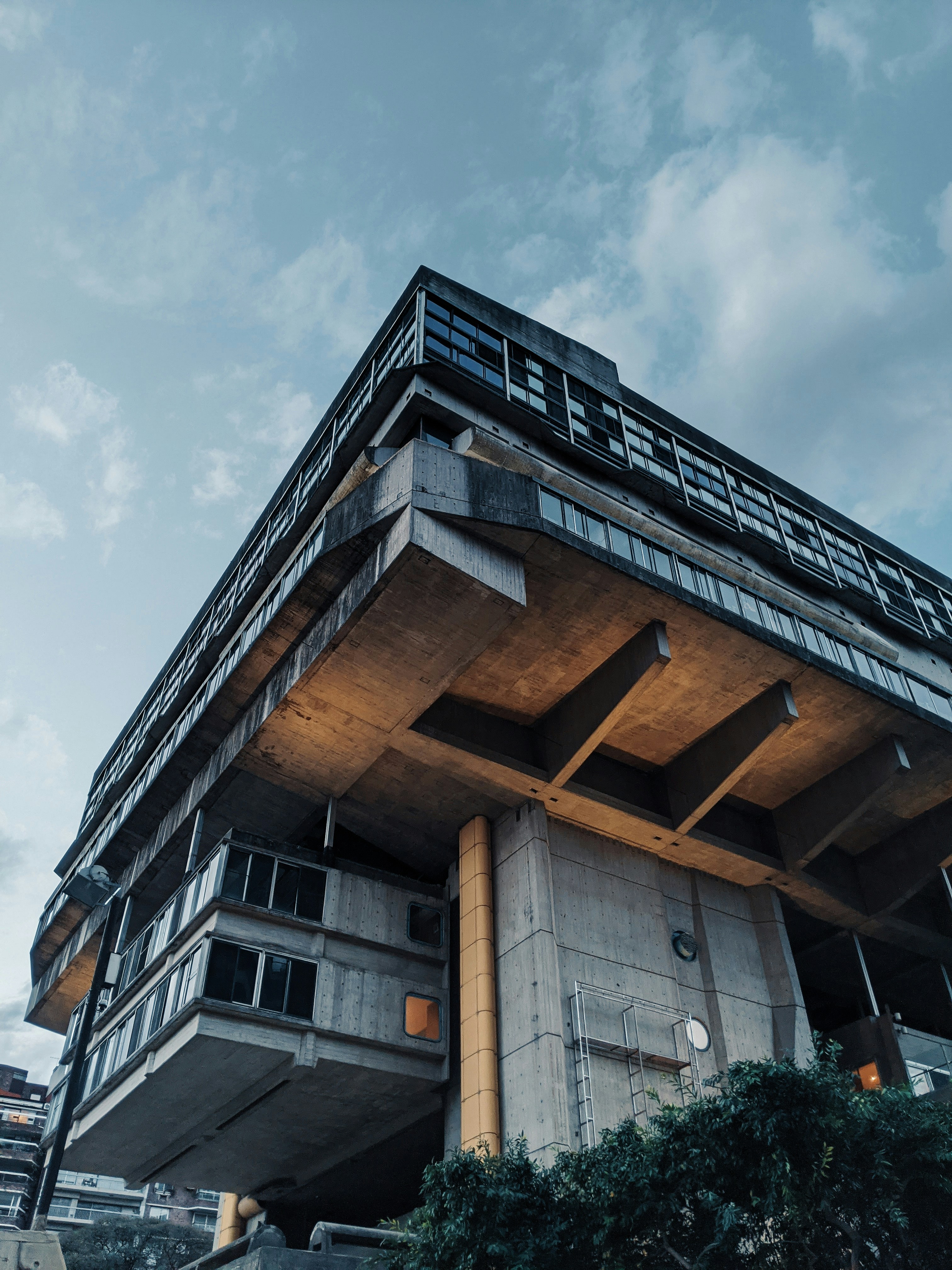 Brown and white concrete building under white clouds during daytime ...