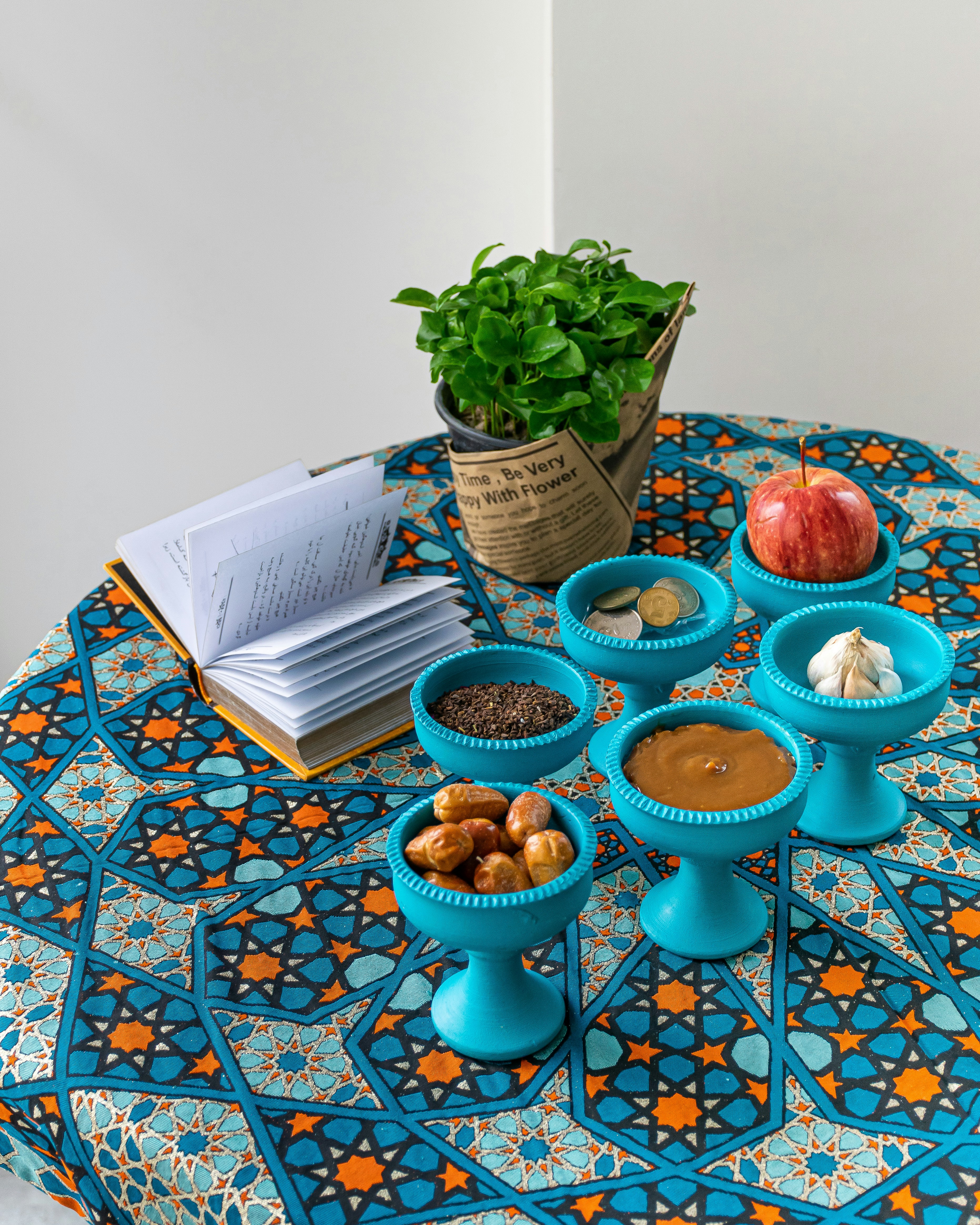 Cerulean Pedestals Surround a Verdant Centerpiece on a Geometric Tablecloth