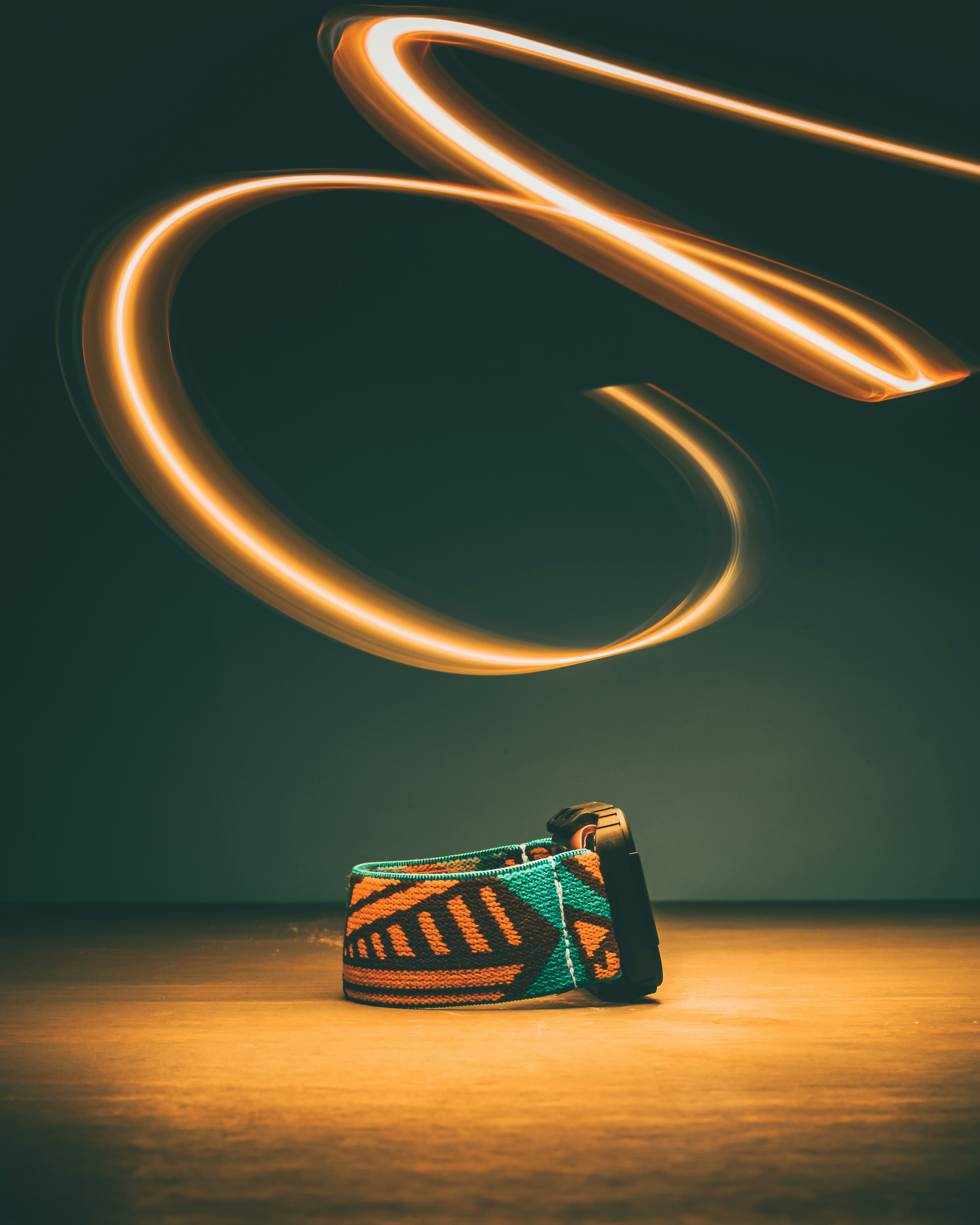 Copper Light Spirals Over a Handwoven Pouch on a Studio Floor