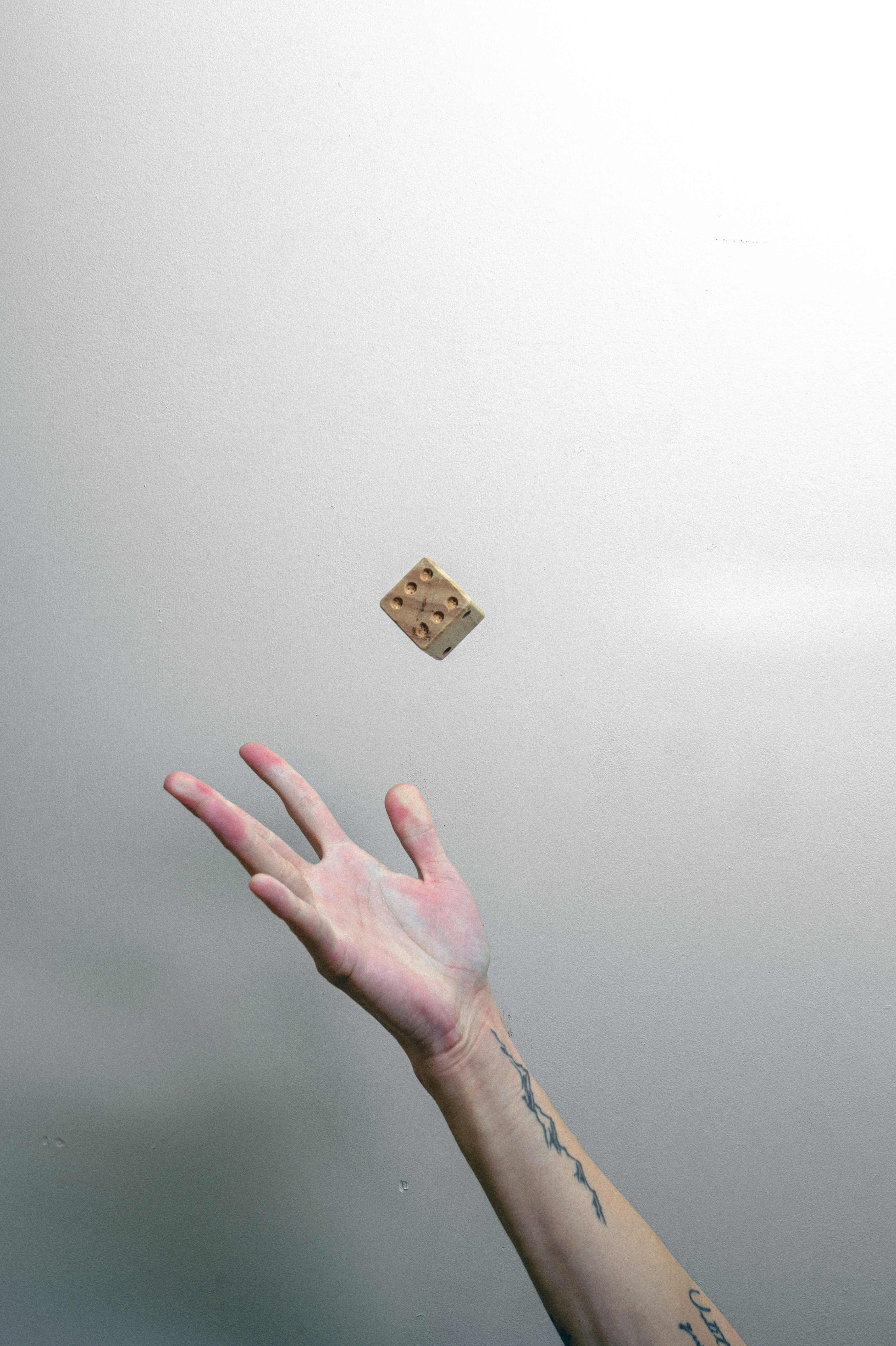 Dice Toss in Silence: a Gloved Moment of Floating Chance