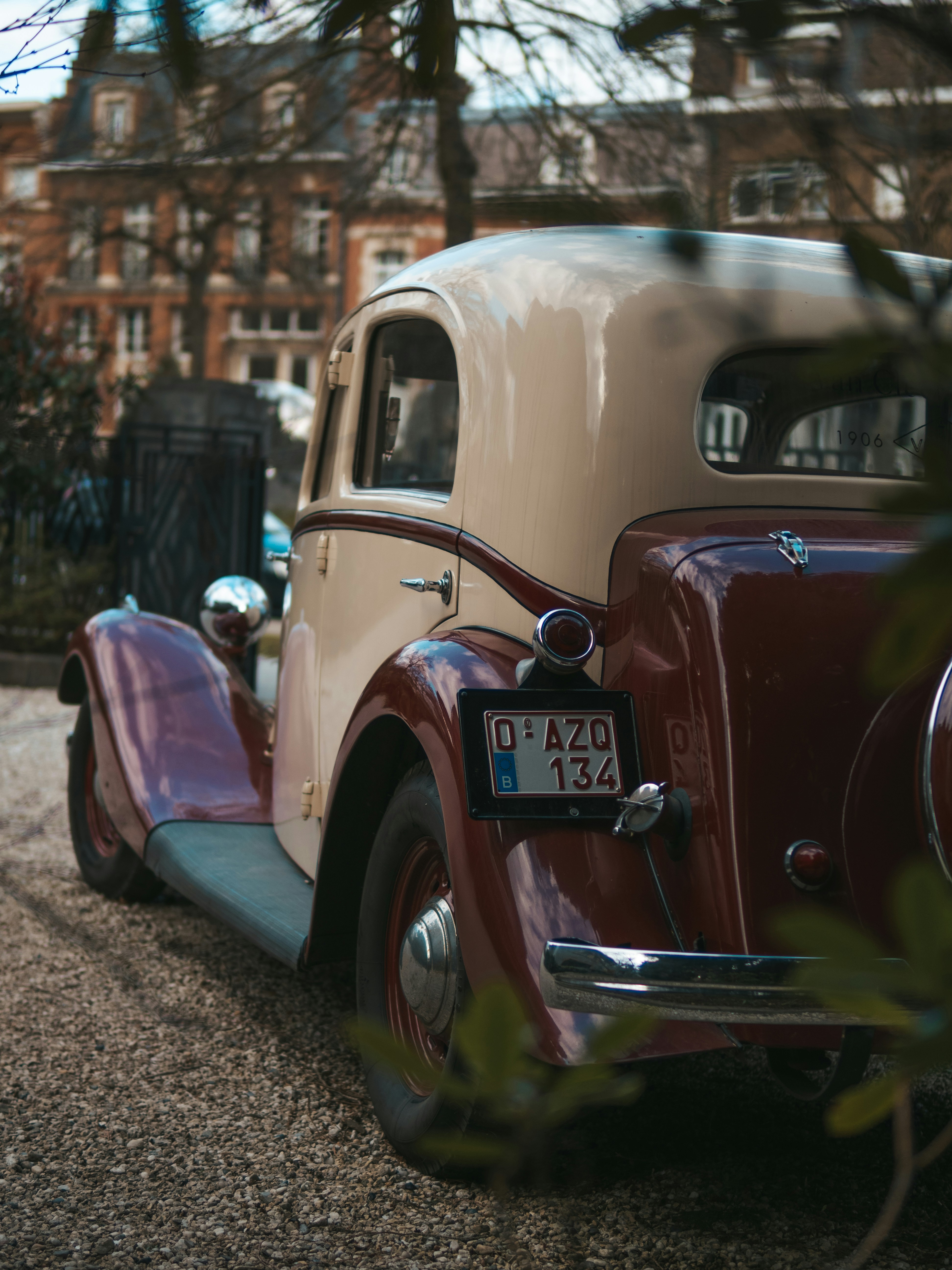 red and white vintage car on brown soil during daytime