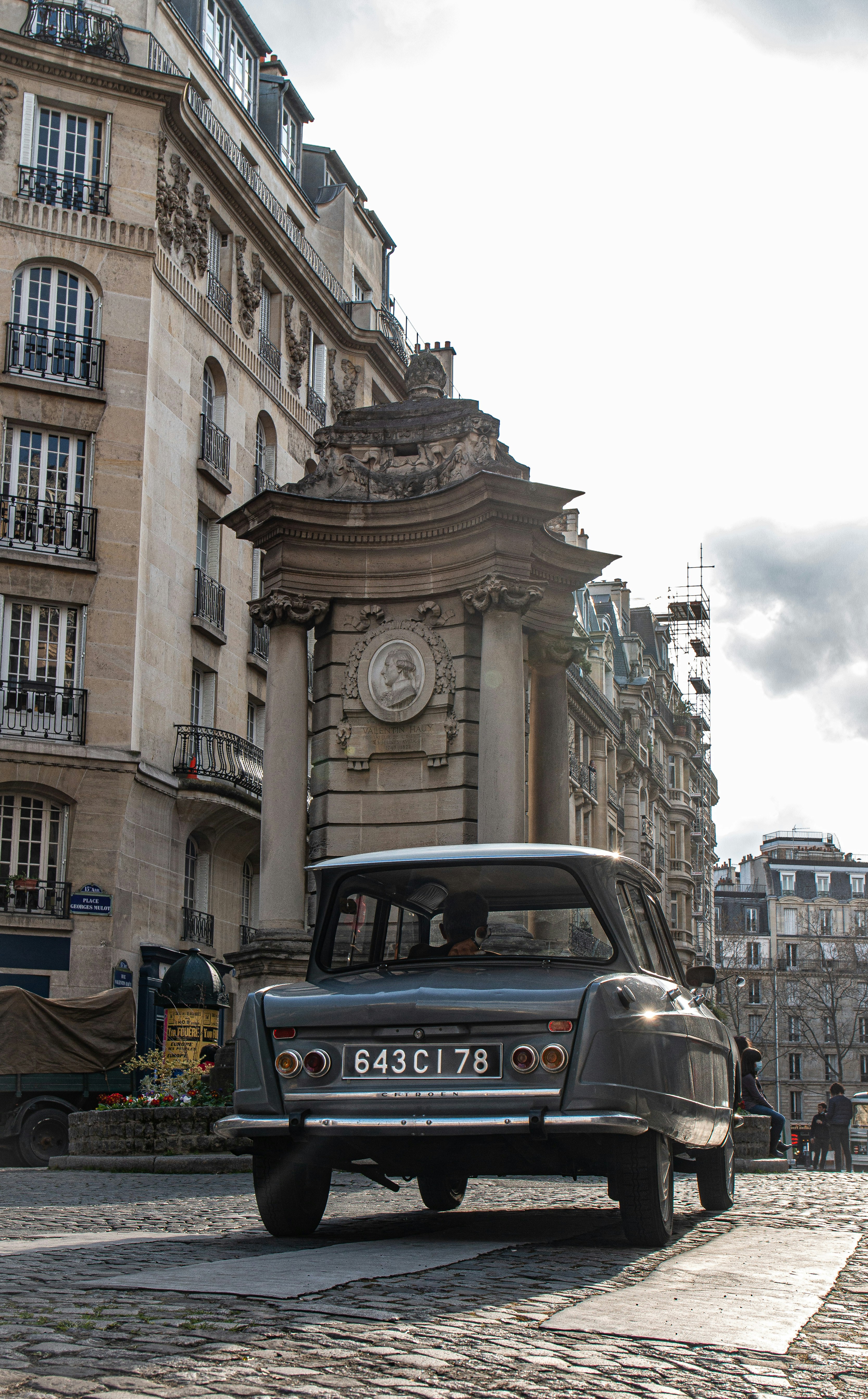The Velvet Sedan and the Stone Monument: A Paris Street Portrait