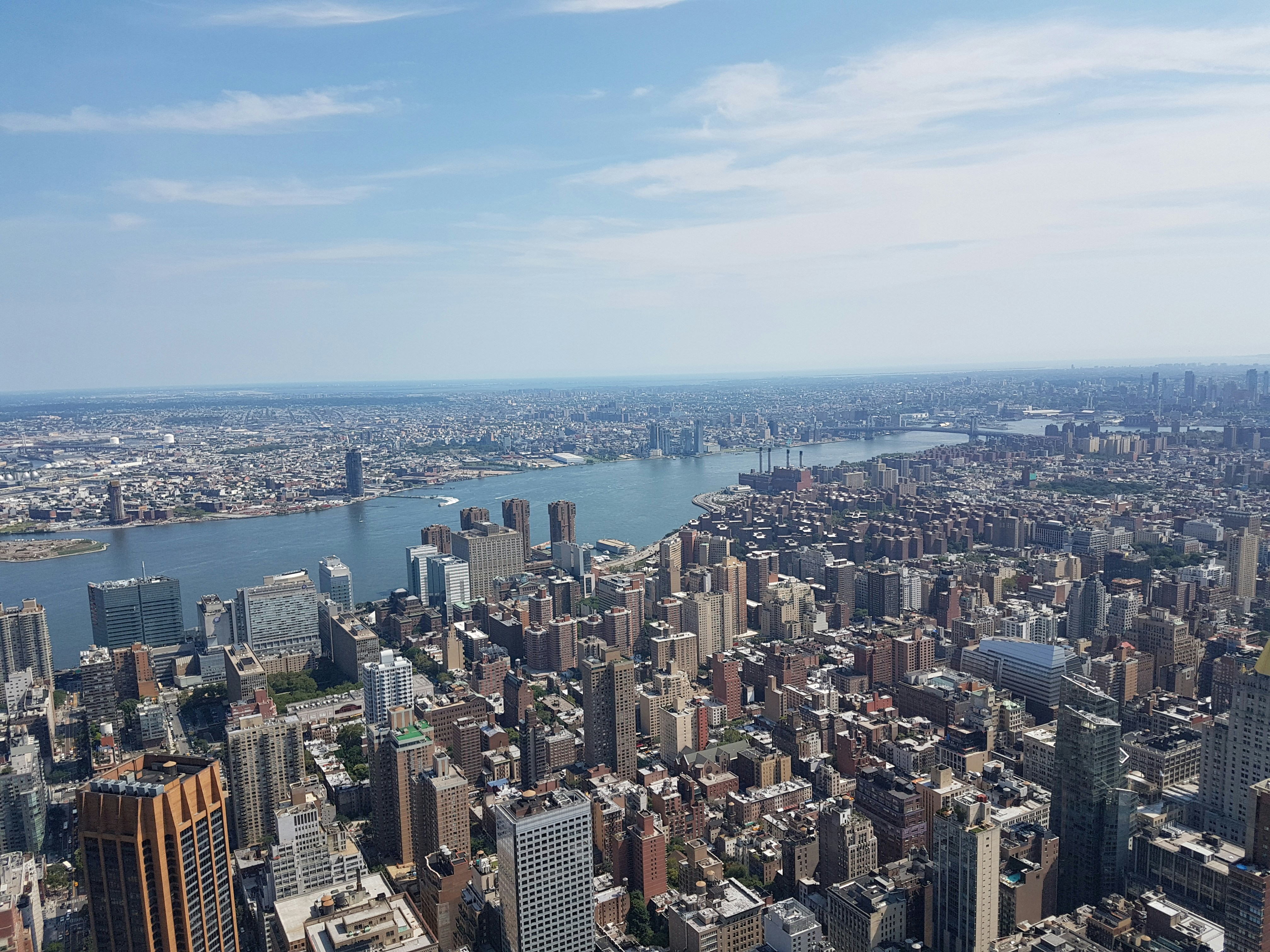City Above the River: A Skyward View of Manhattan's Grid and Bridges