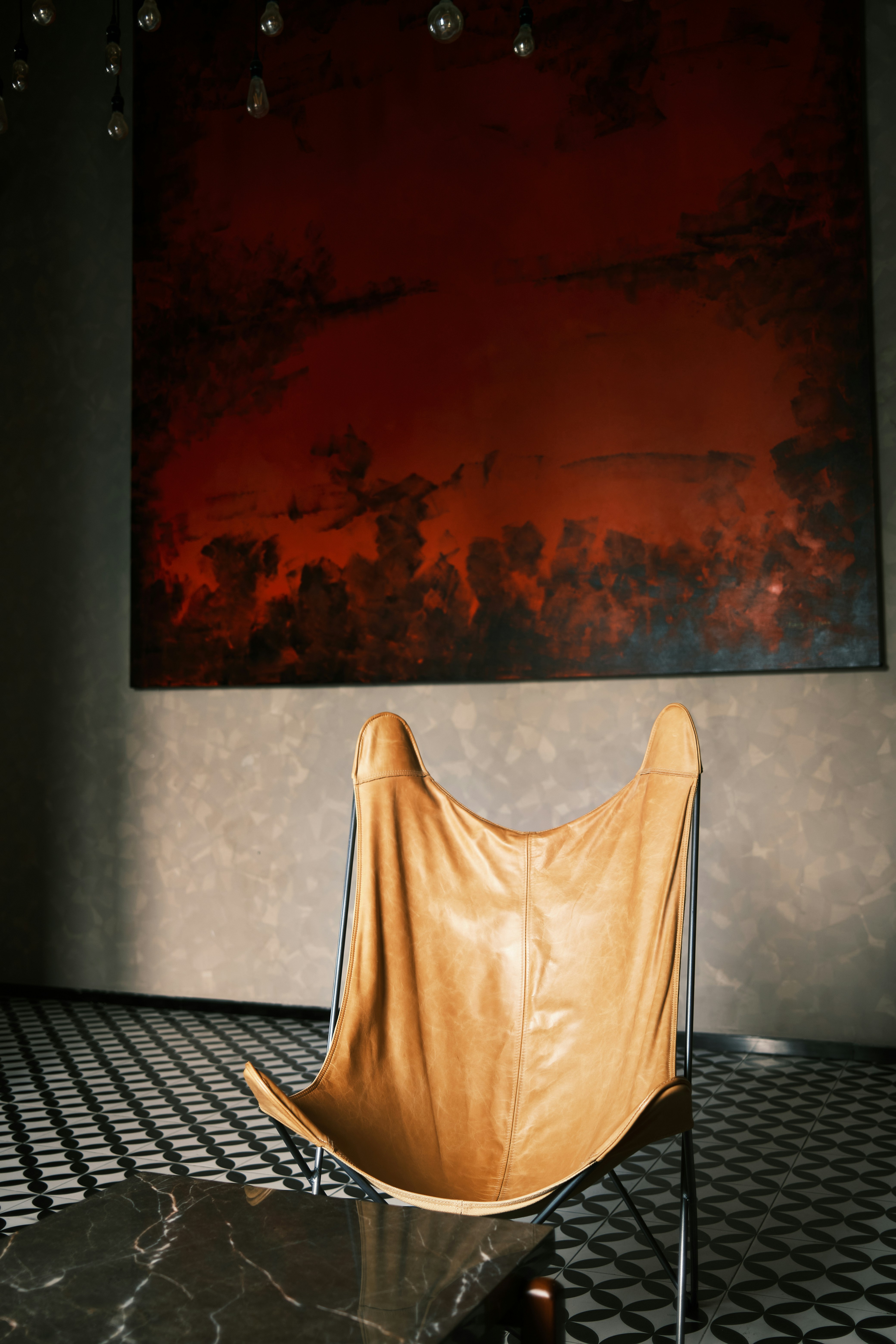 Amber Leather Butterfly Chair Beneath a Crimson Gallery