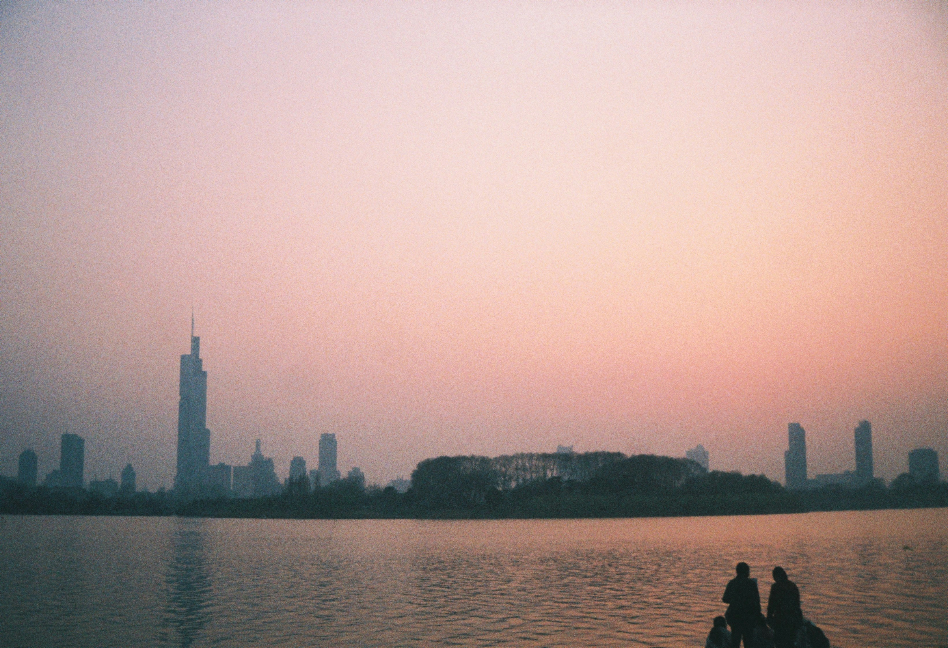 silhouette of man and woman standing on dock during daytime