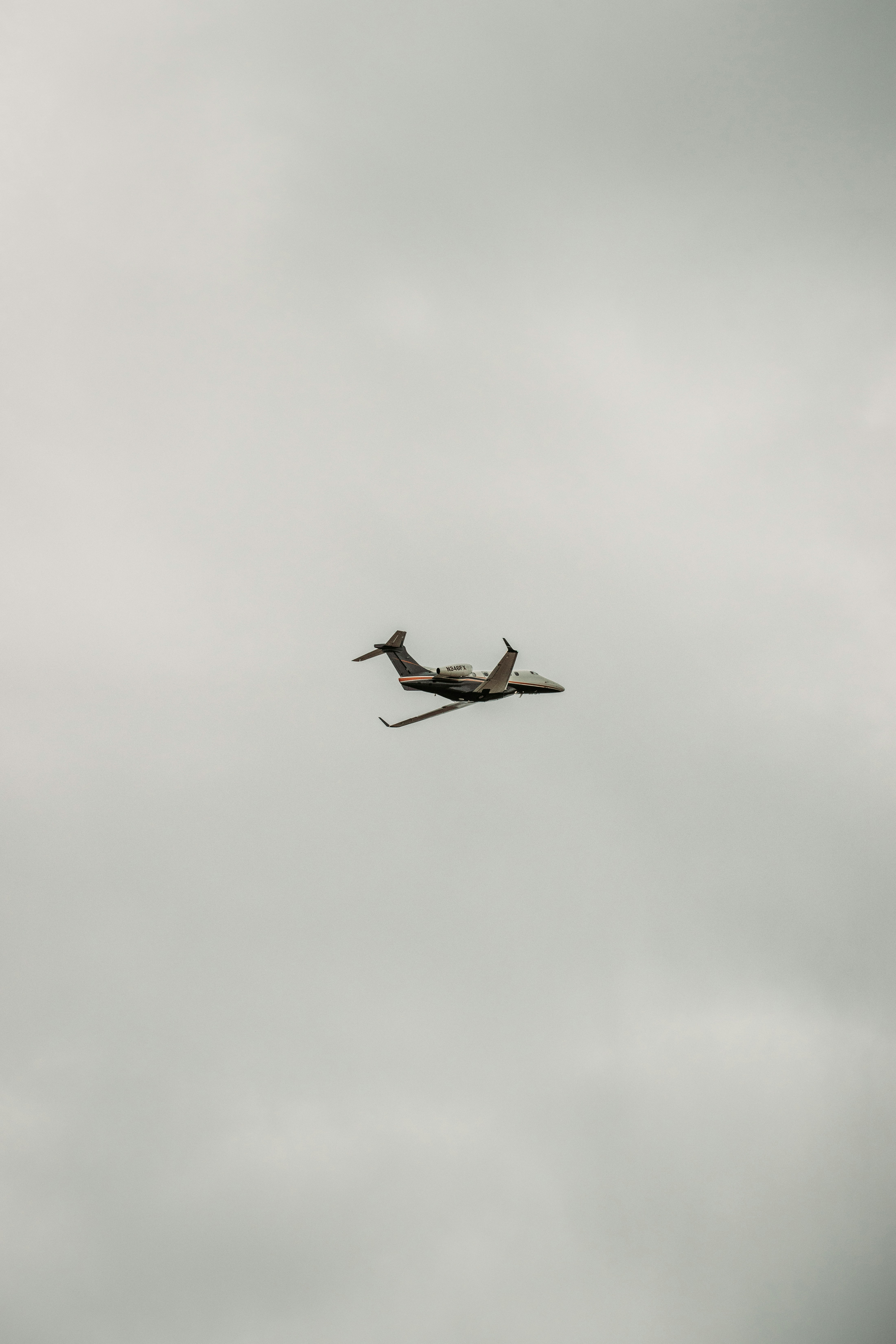 Midair Minimalism: A Tiny Jet in Overcast Silence