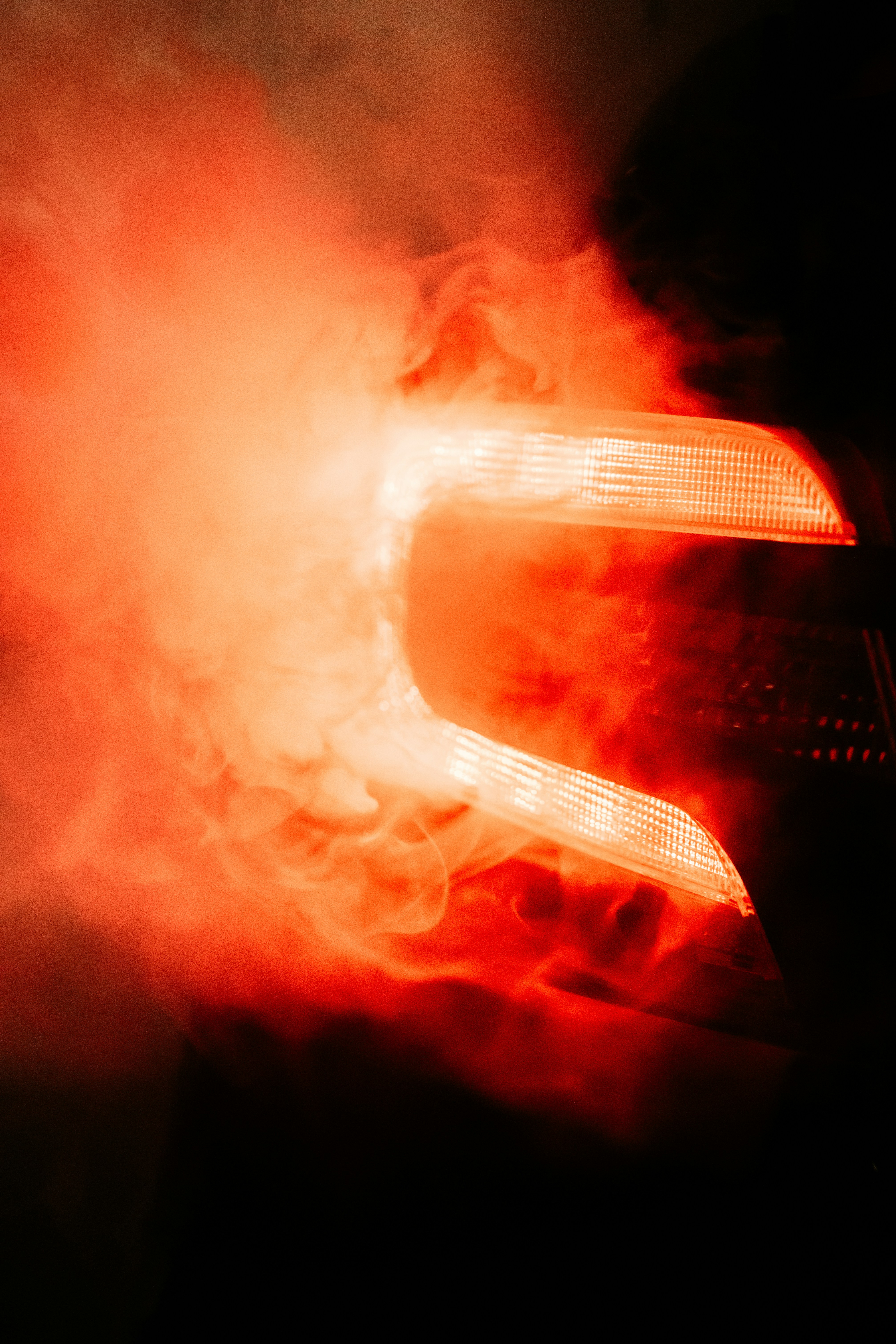 Crimson Trail through Smoke: A Tail Light’s Quiet Fury in the Dark