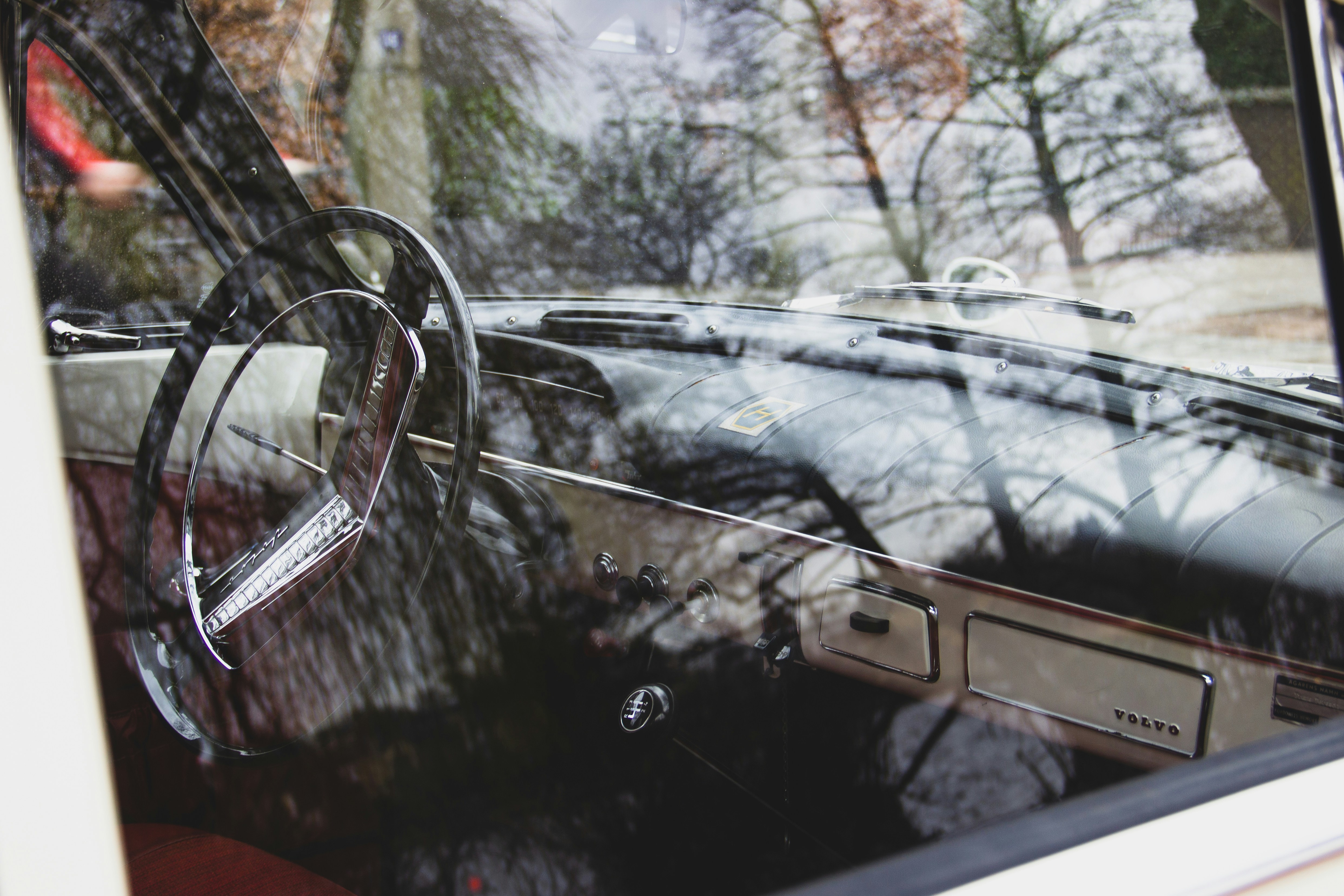 Vintage Car Interior Through Glass: Reflections Framing the Dash