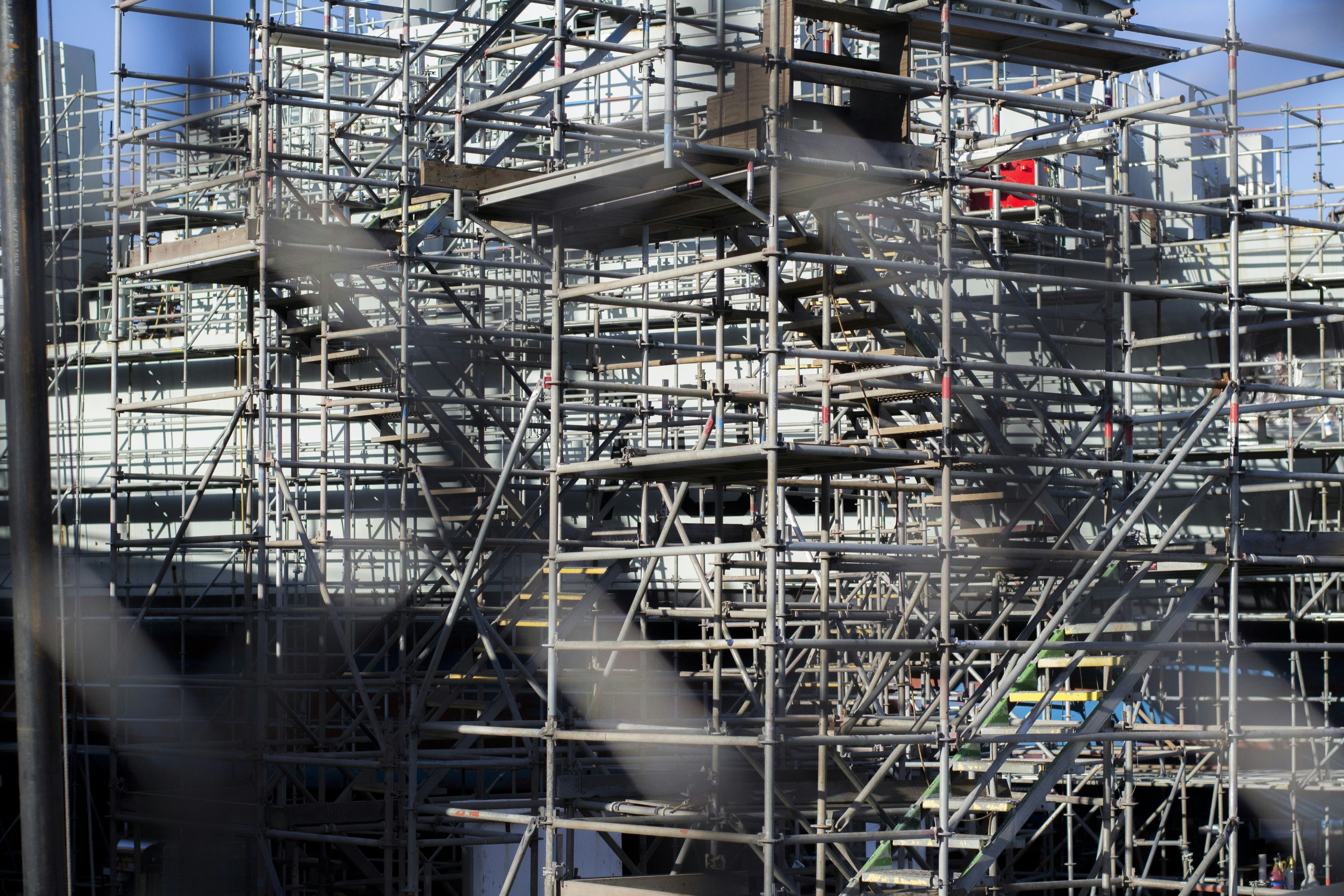 Complex arrangement of scaffolding and structural elements at a construction site. The image showcases the layers and patterns formed by the scaffolding.