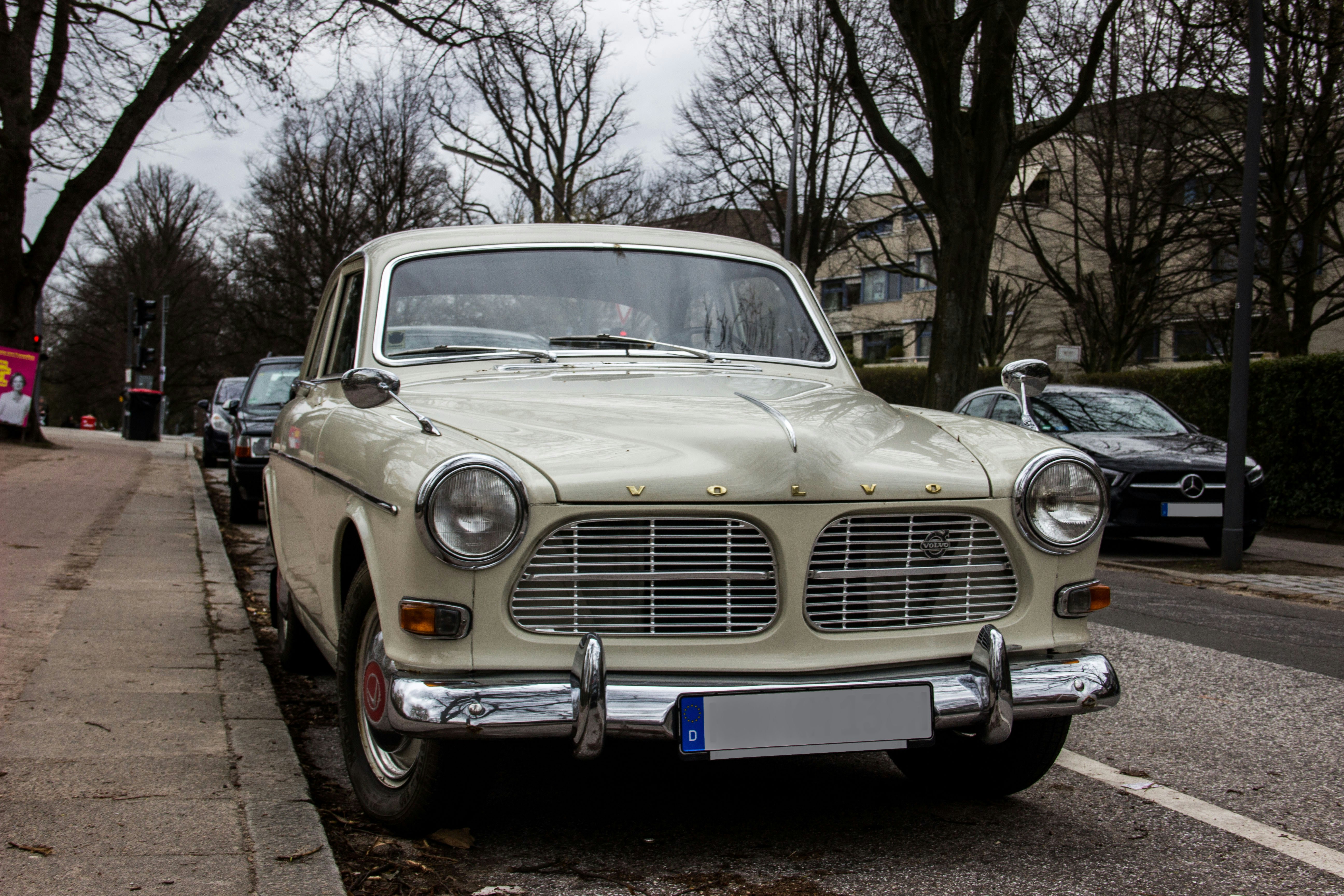 Beige Vintage Sedan Beckons: Front View on a Quiet Tree-Lined Street