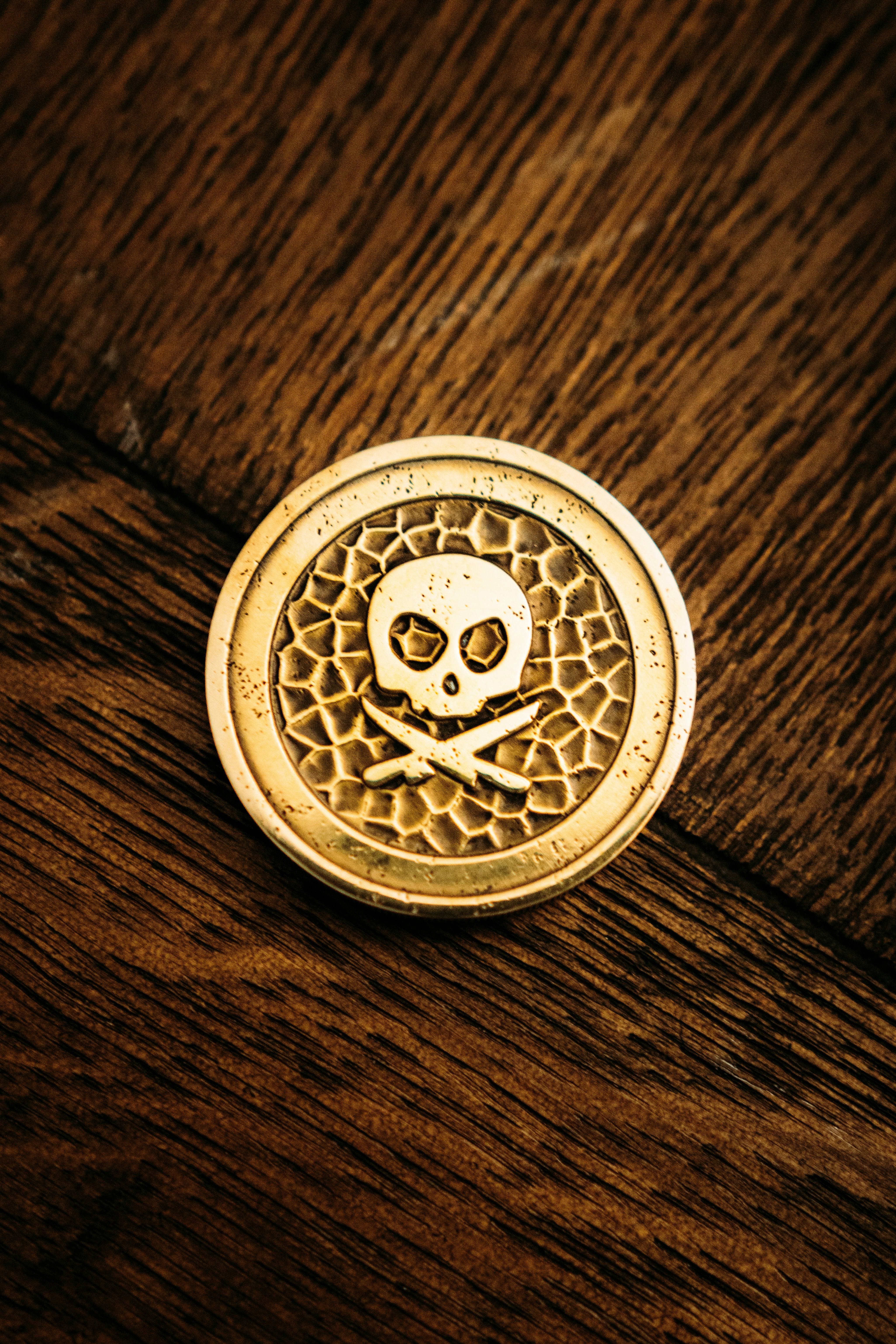 Gold Skull Emblem on Weathered Wood: A Quiet Moment with a Subtle Hazard