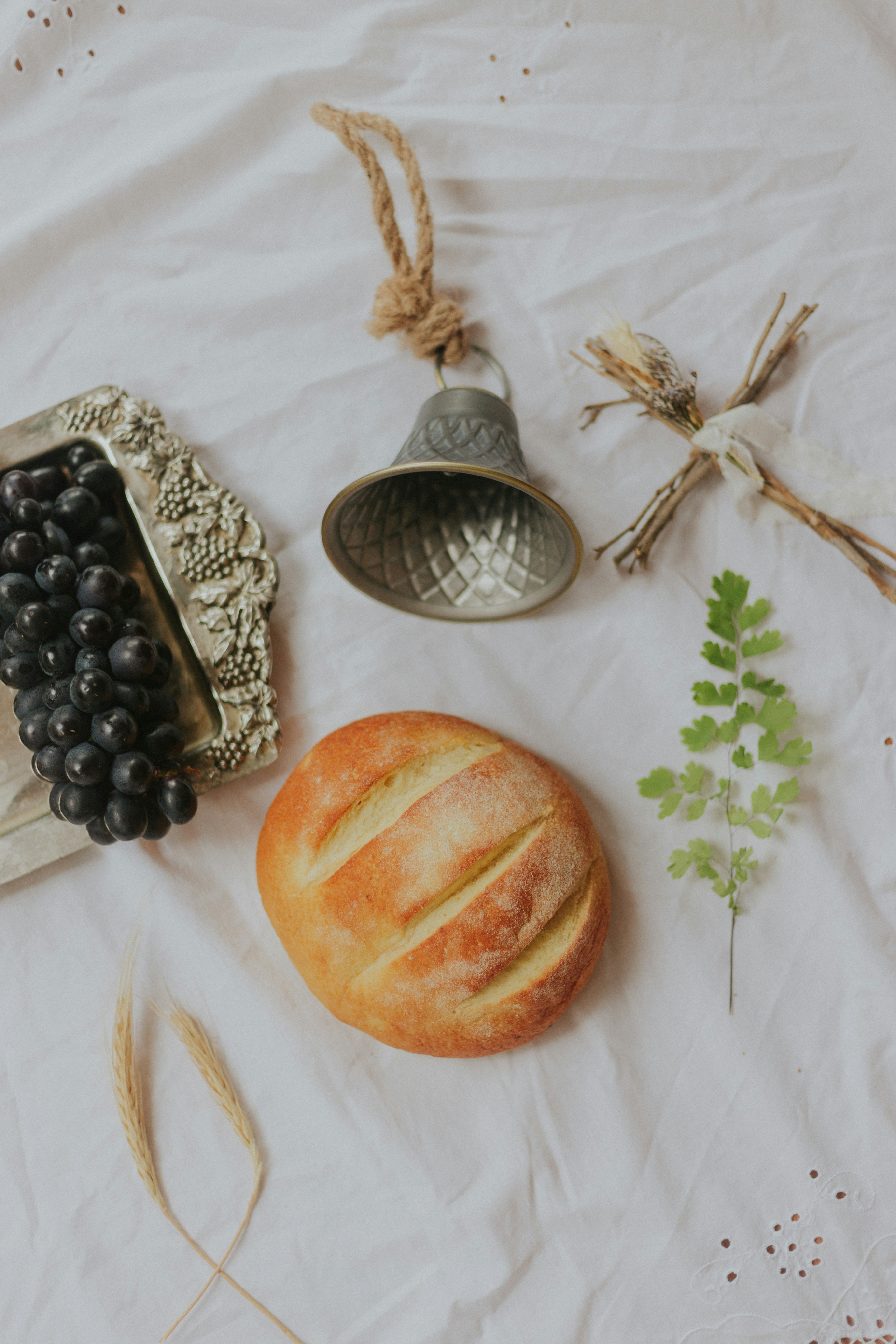 Rustic Round Loaf and Grapes: A Quiet Still-Life on Linen