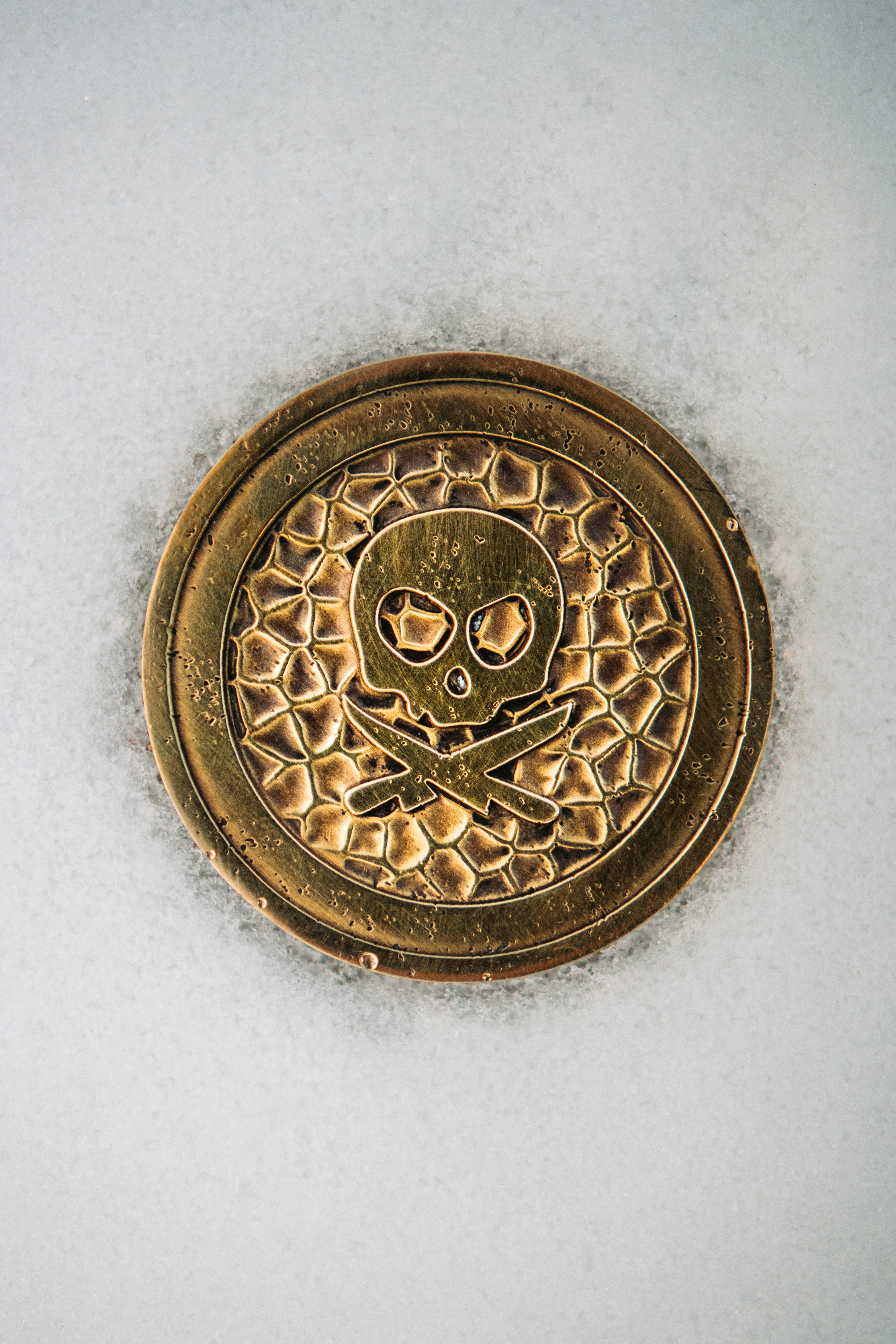 Gold round coin on white table photo – Free Hero subject Image on Unsplash