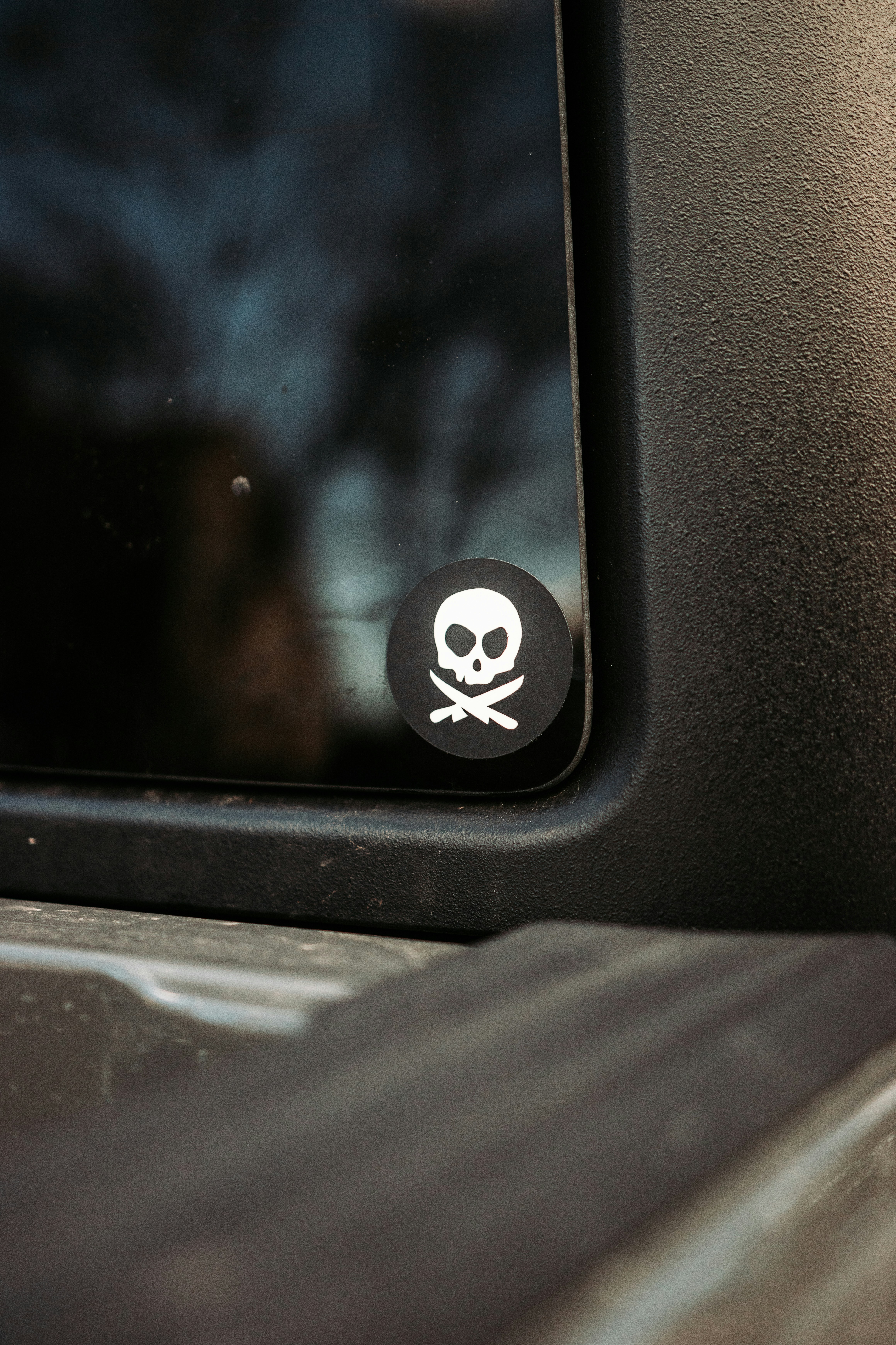 Skull Sticker at the Window Nook of a Quiet Vehicle