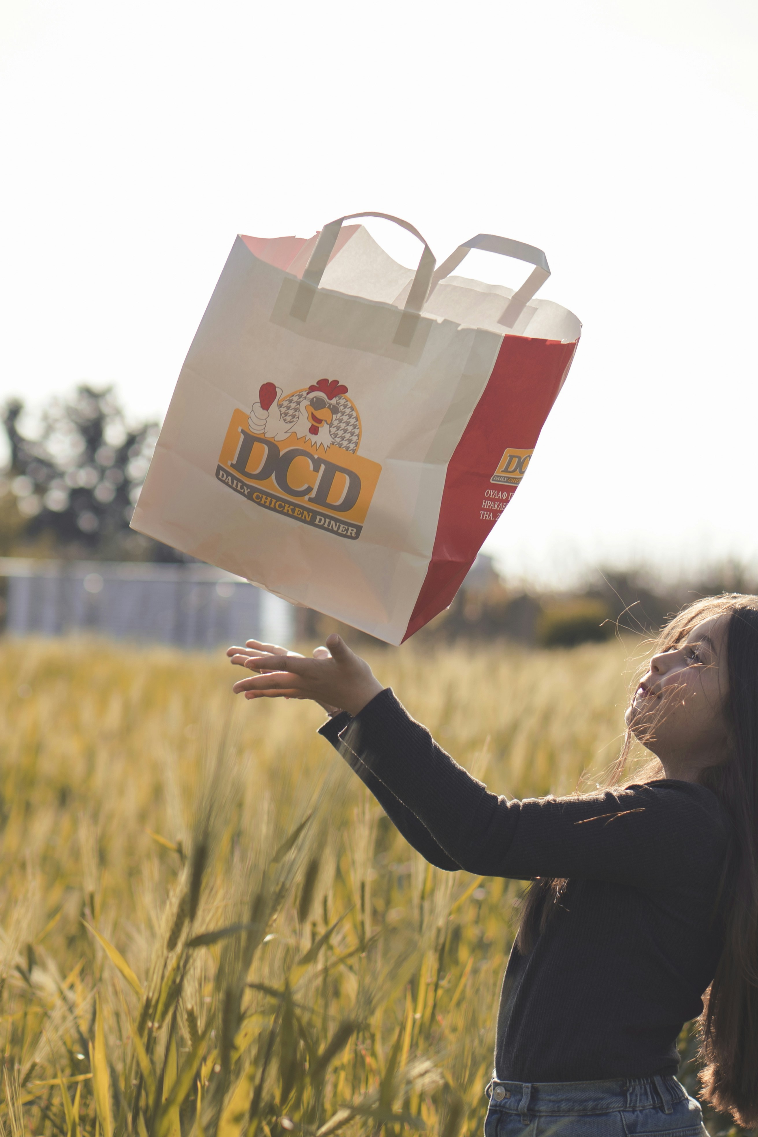 Flight of a DCD bag over a sunlit field