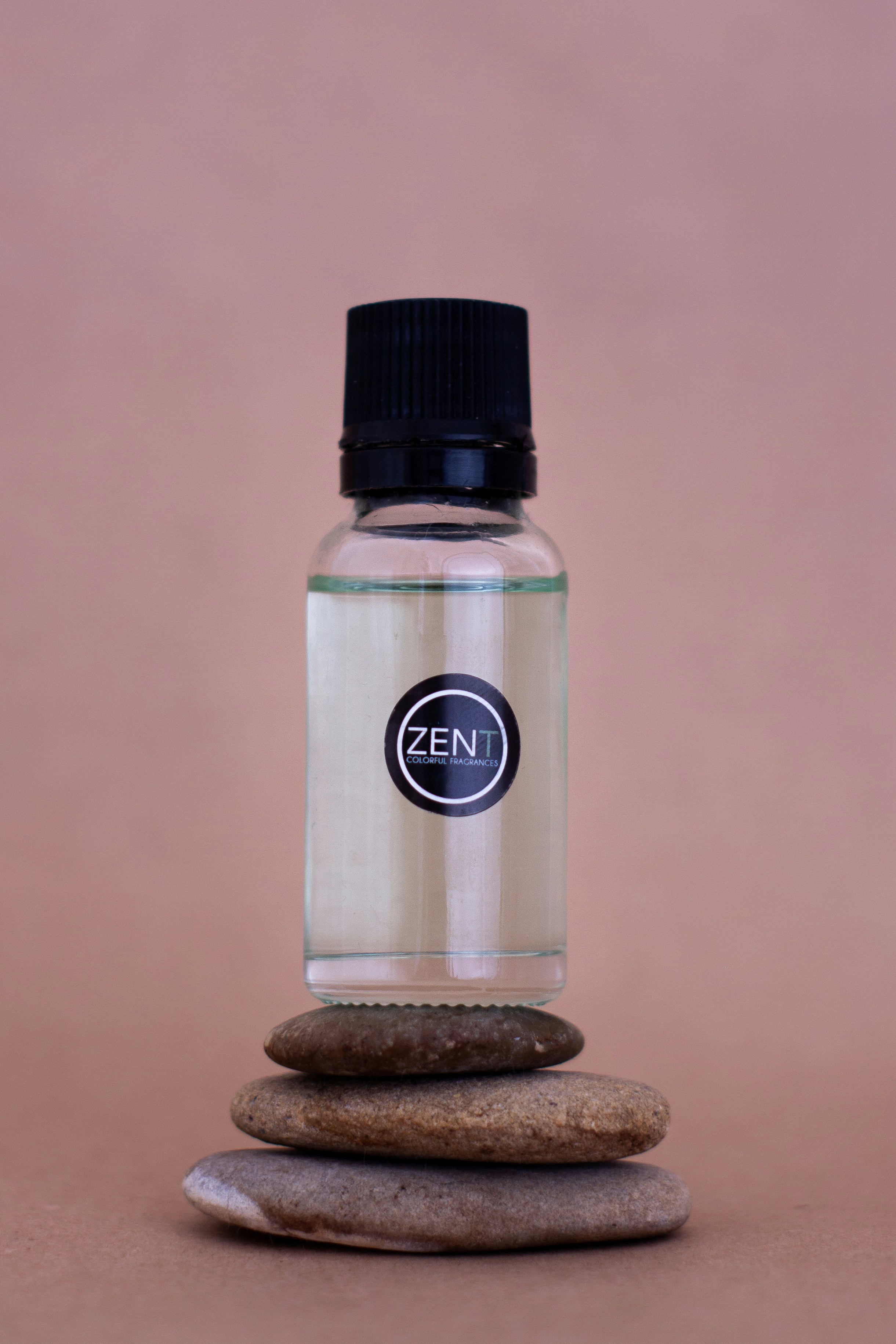 Zen on Pebbles: The Clear ZENT Bottle Balancing on a Rock Stack