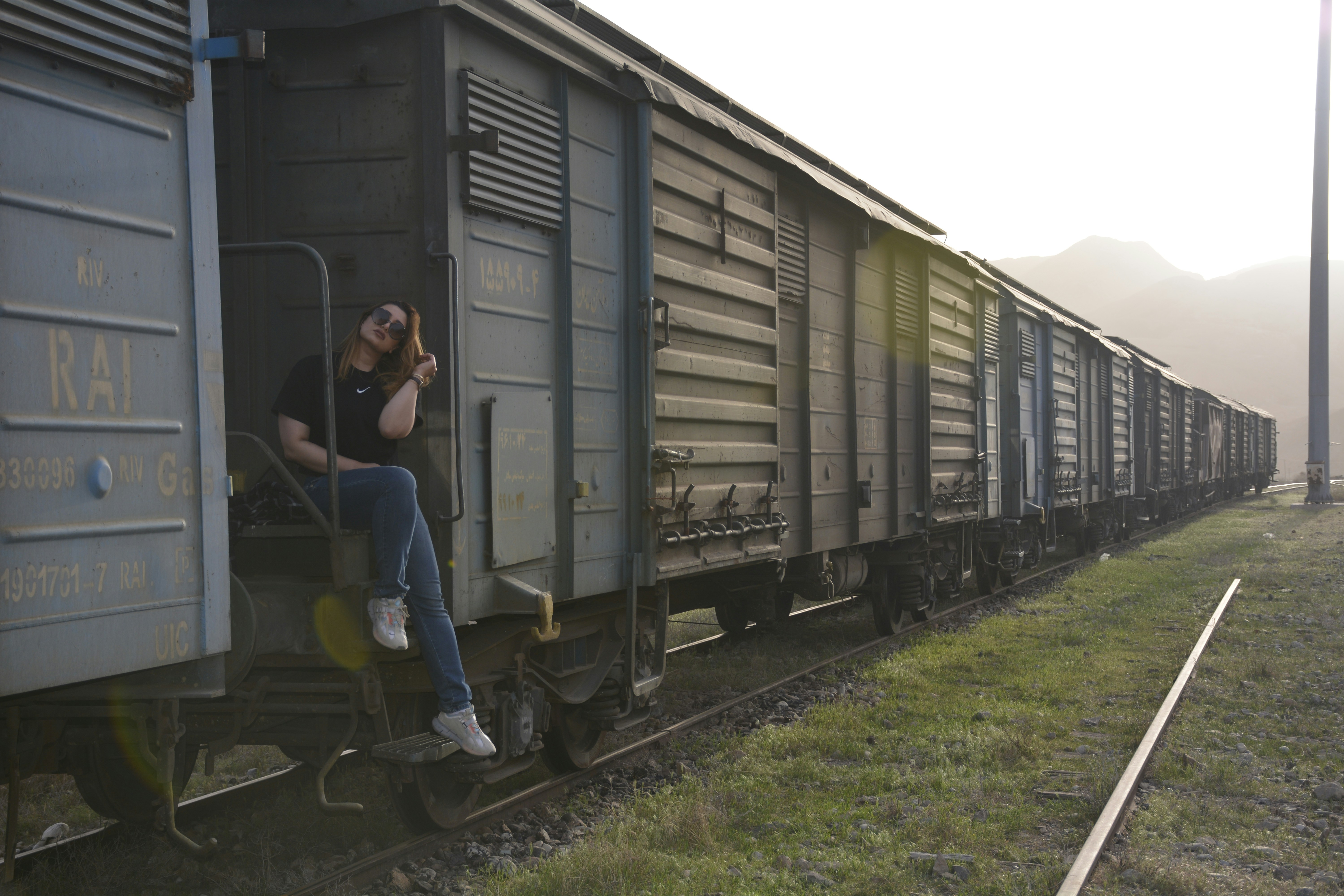 Dawn Light Through an Open Railcar Door: A Quiet Figure Pauses on the Threshold