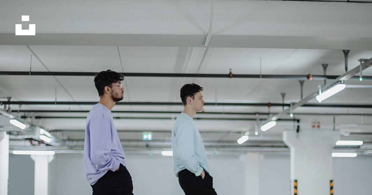 Man In White Shirt And Black Pants Standing Beside Woman In White Shirt