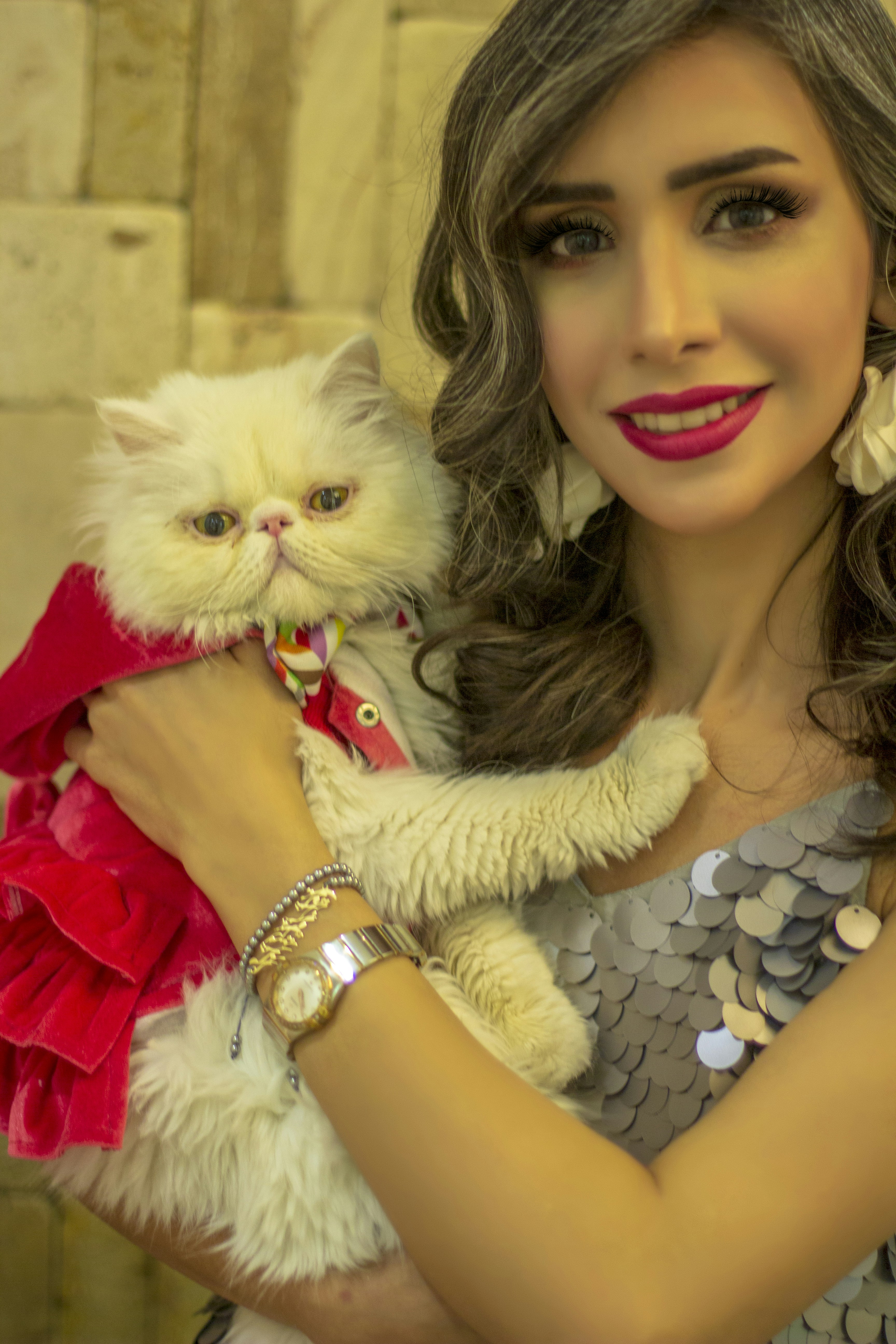 Elegant Smile and Fluffy Companion: The Glamourous Duo