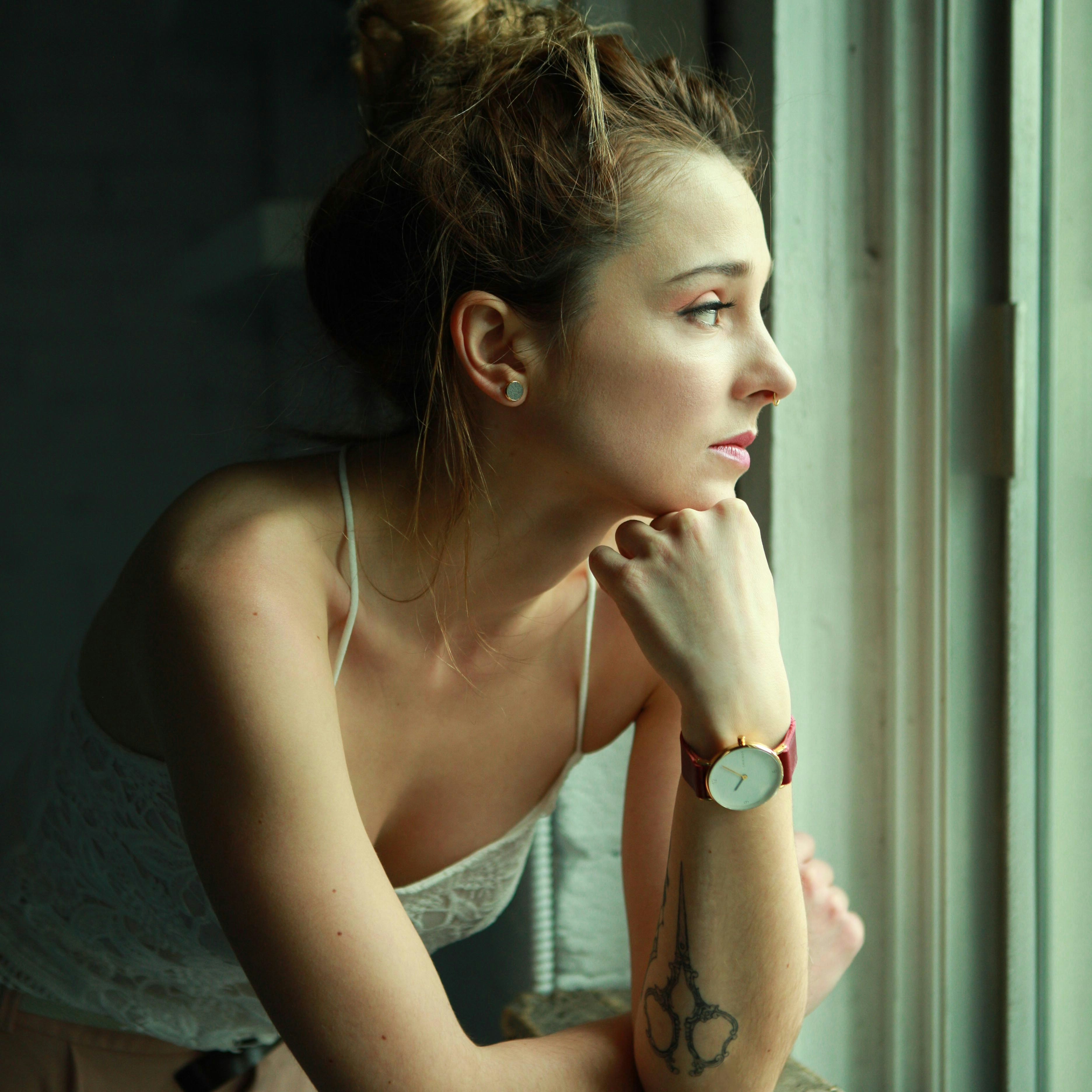 Woman in white tank top leaning on wall photo – Free Woman Image on ...