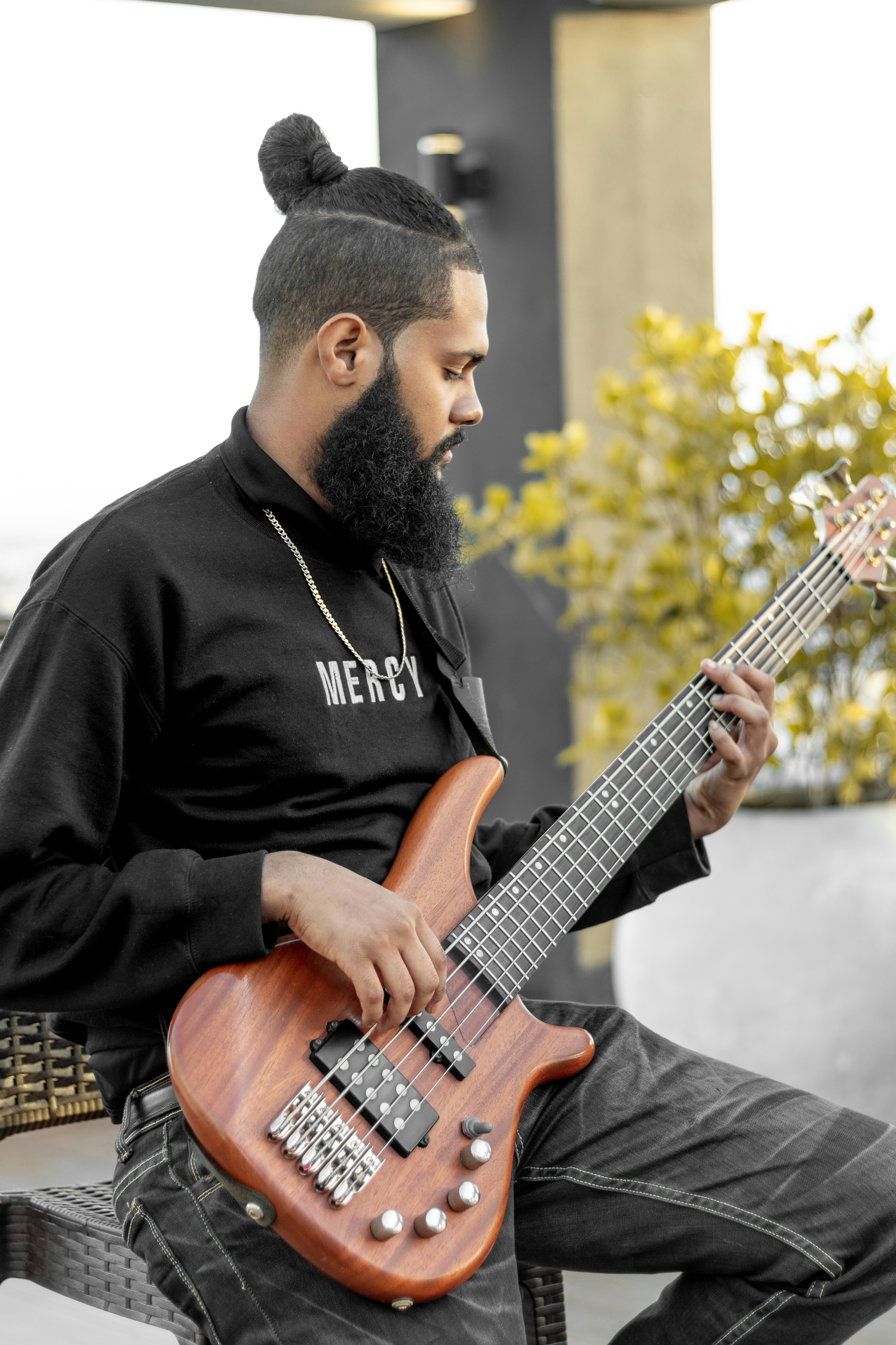 Rooftop Groove: A Bearded Bassist in Focus