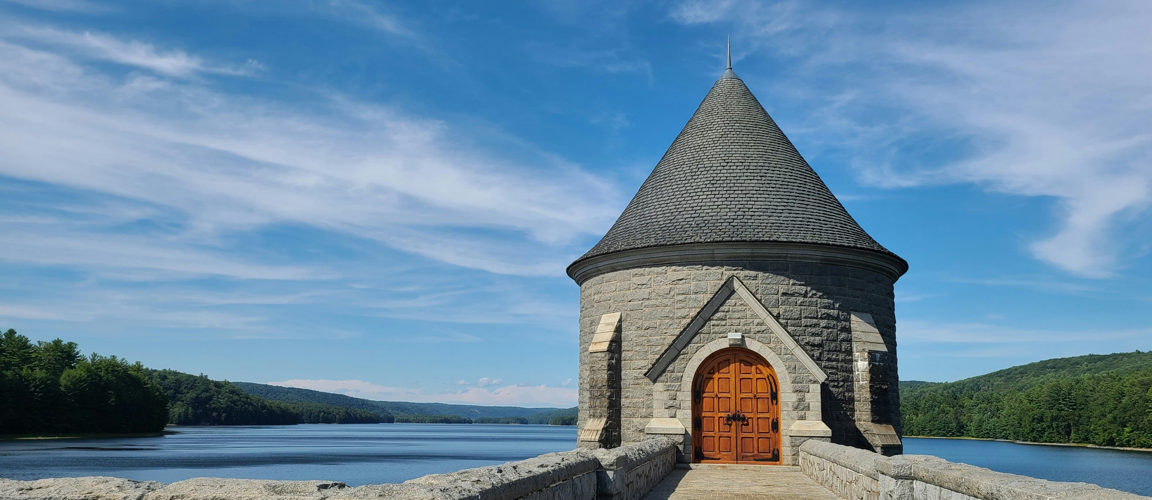 Barkhamsted Reservoir in Connecticut  | brown and gray concrete building near body of water during daytime