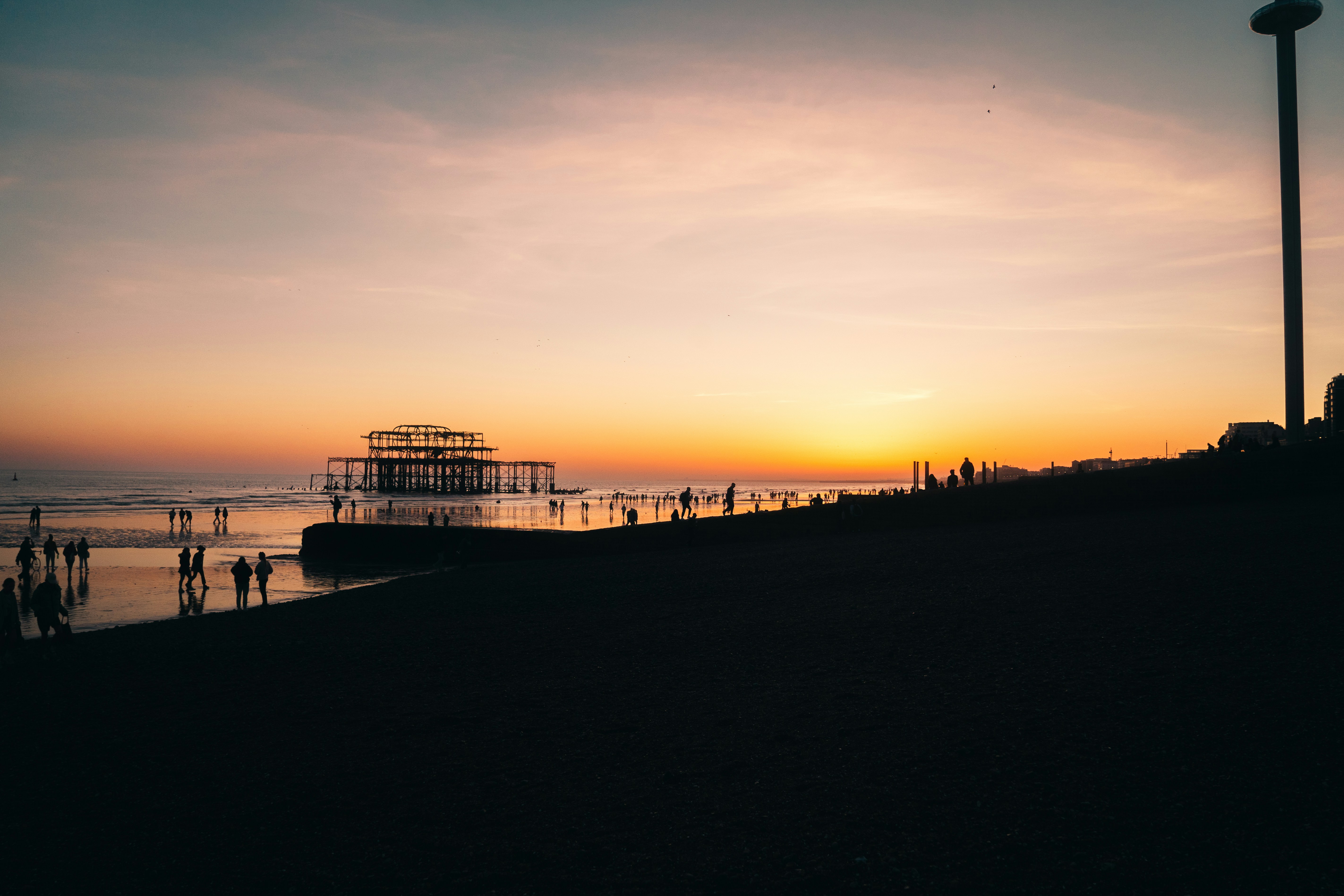 Silhouetted Pier at Sunset: A Quiet Shoreline
