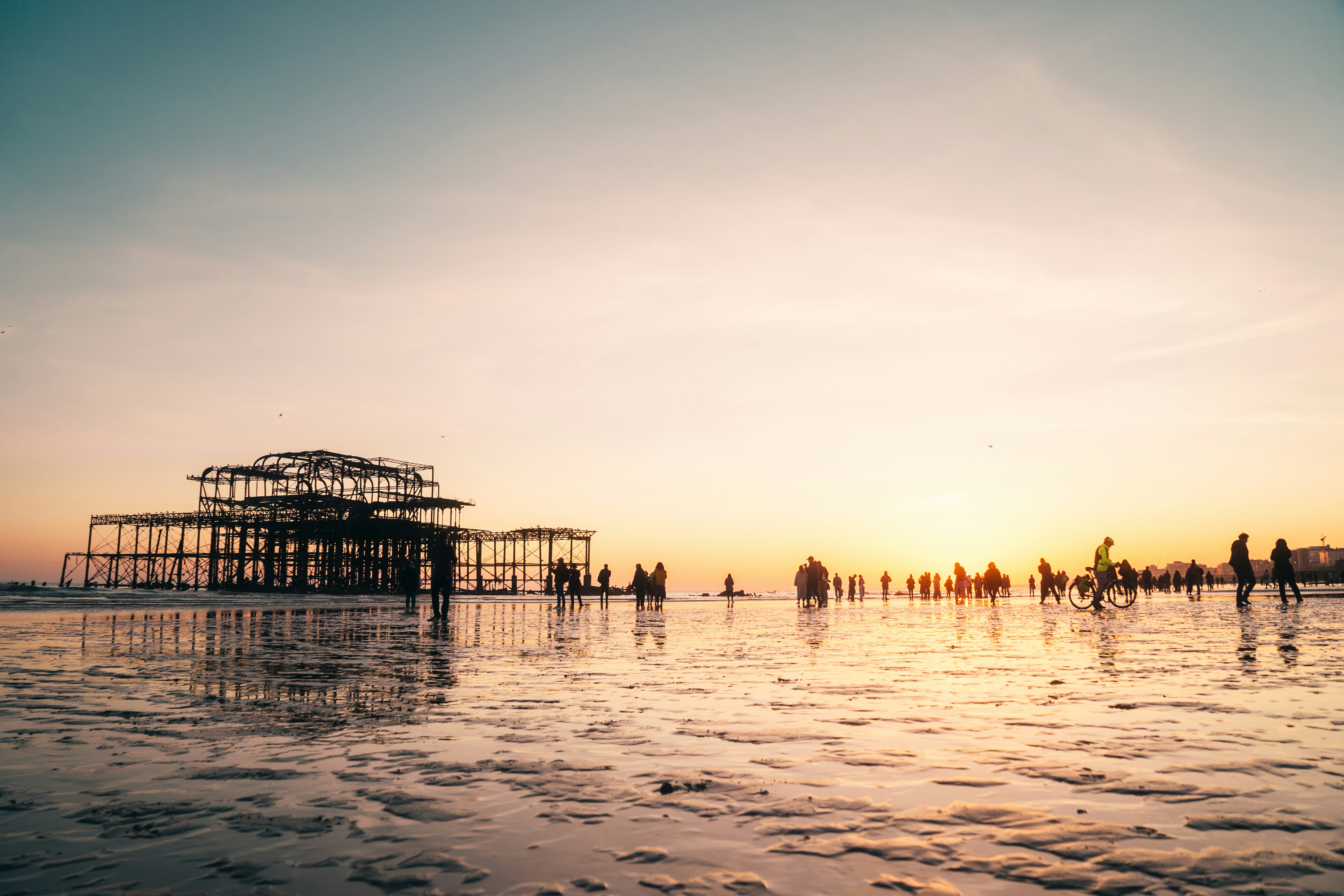 Sunset at the Pier Remnants: silhouettes on the tidal plane