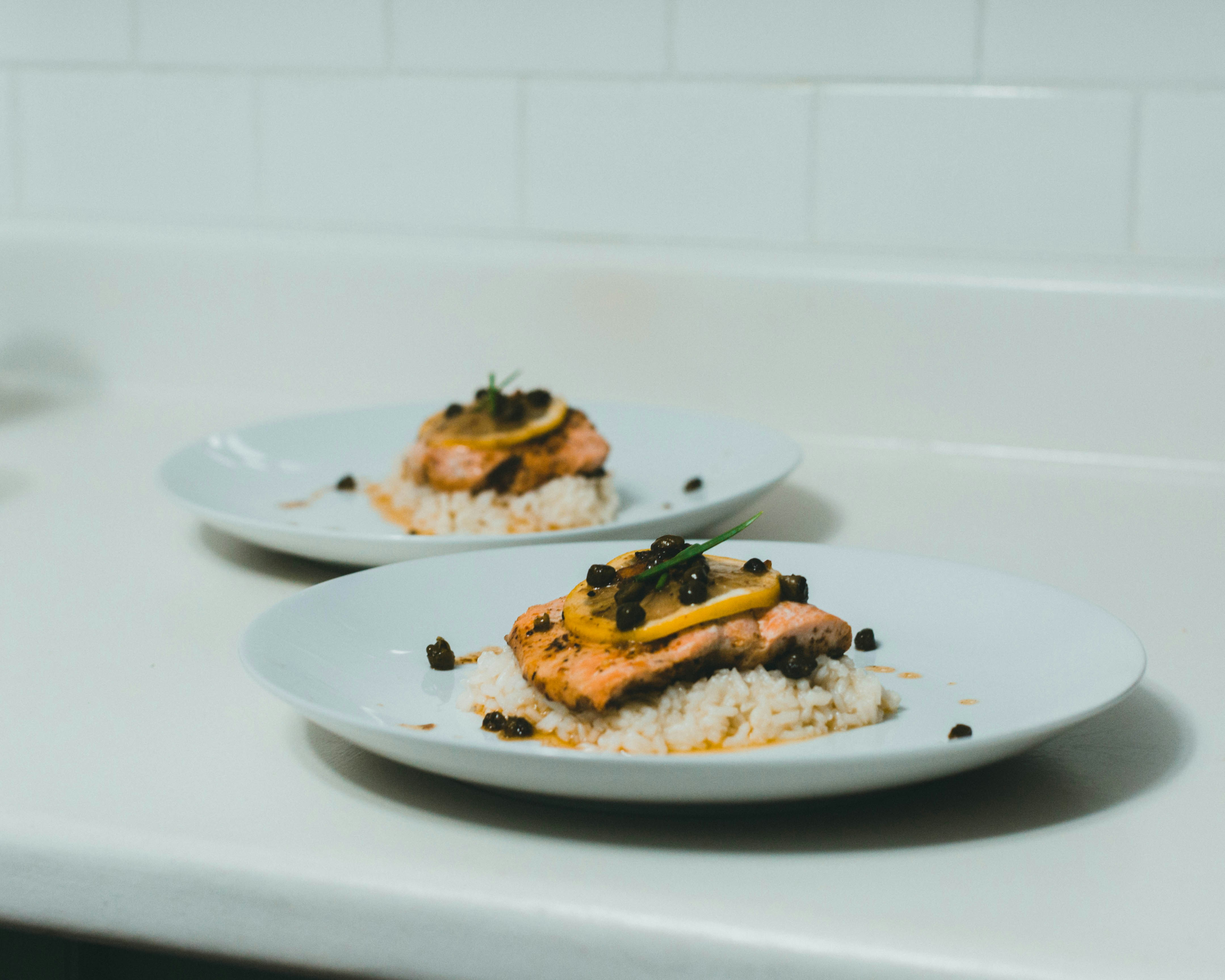 Citrus-Glazed Salmon on Rice, Plated Twice on a Minimal White Counter