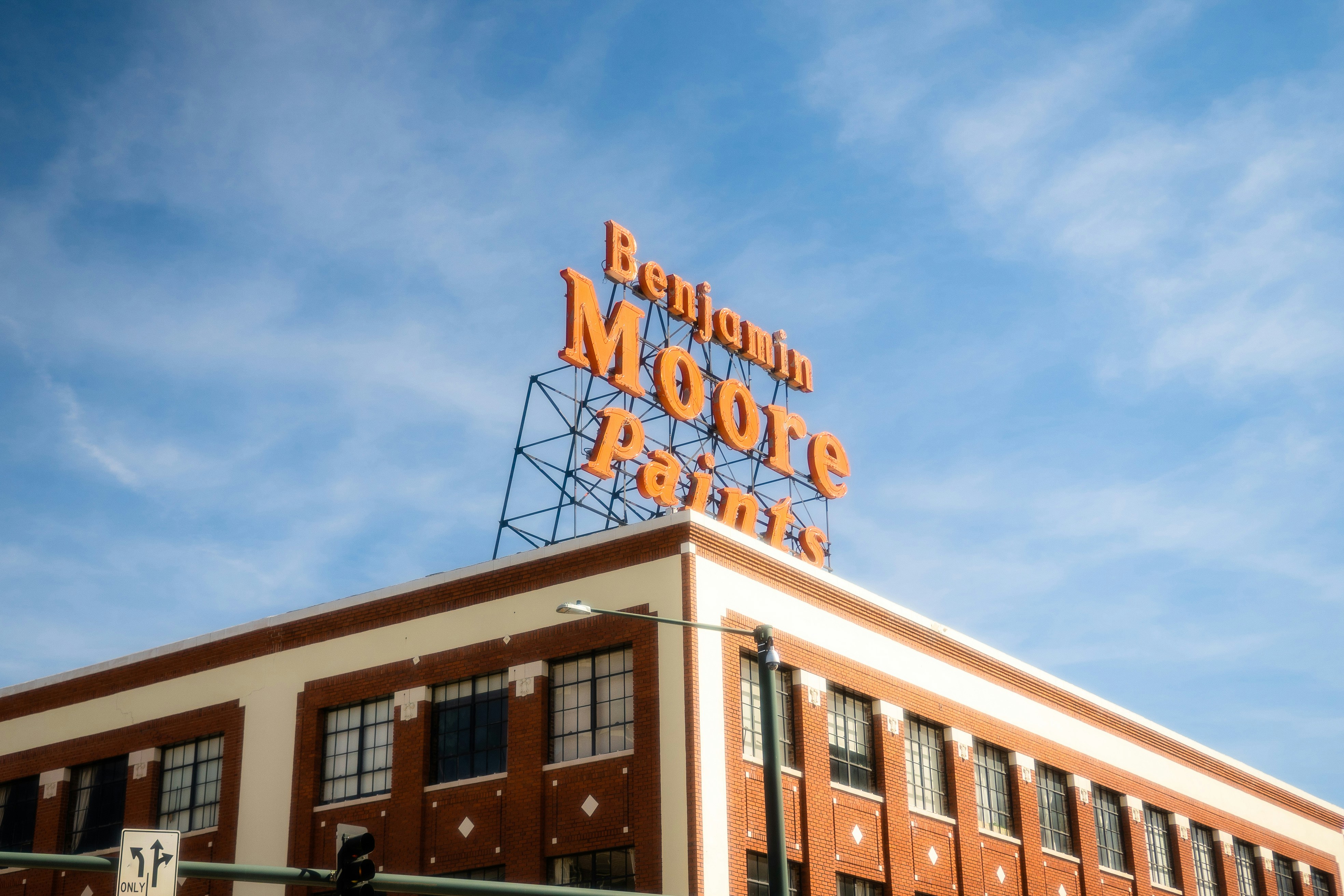 Ben-John Moore’s Painted Sign Rises Over Brick Warehouse