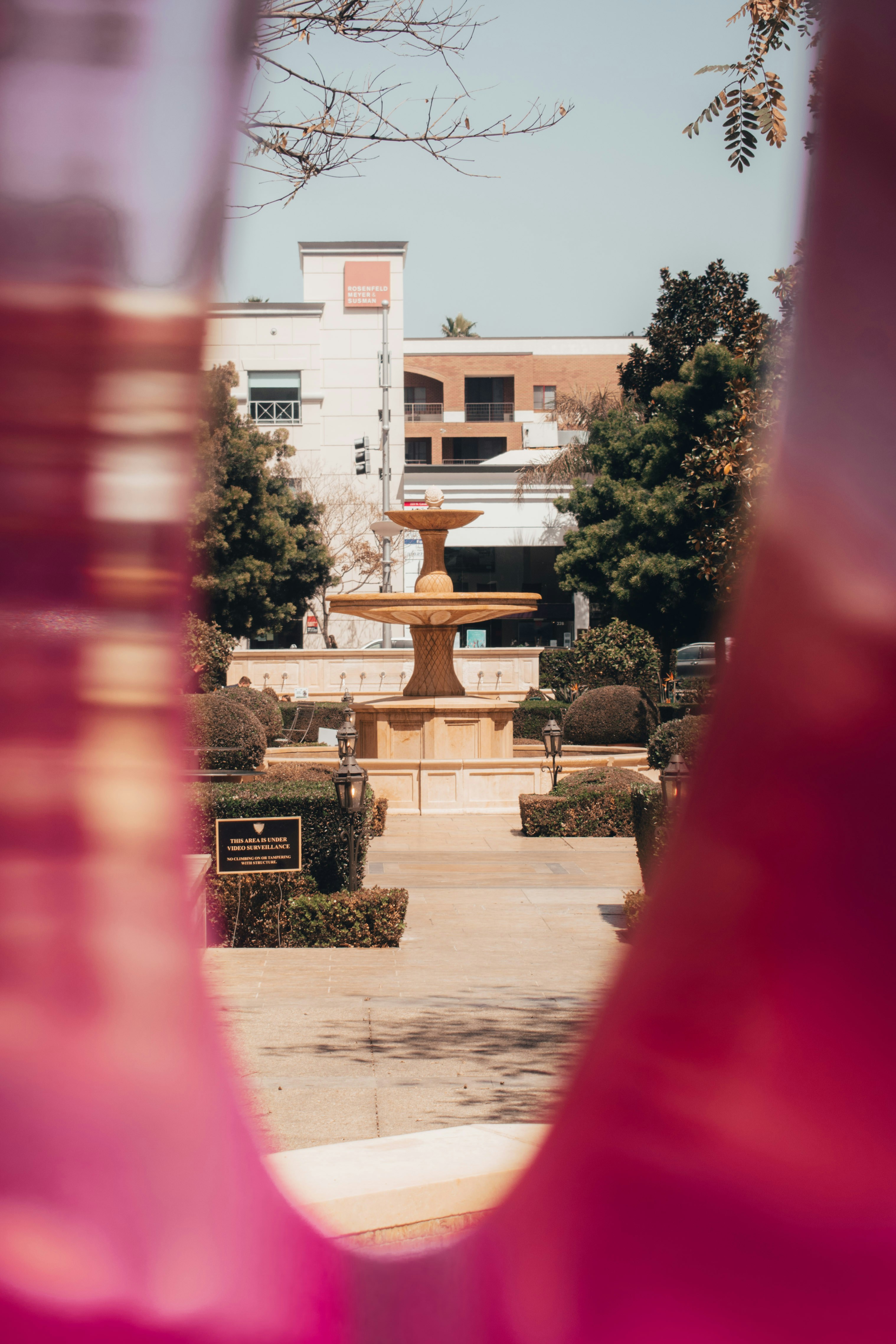 A view of a fountain through a window photo – Free Building Image on ...