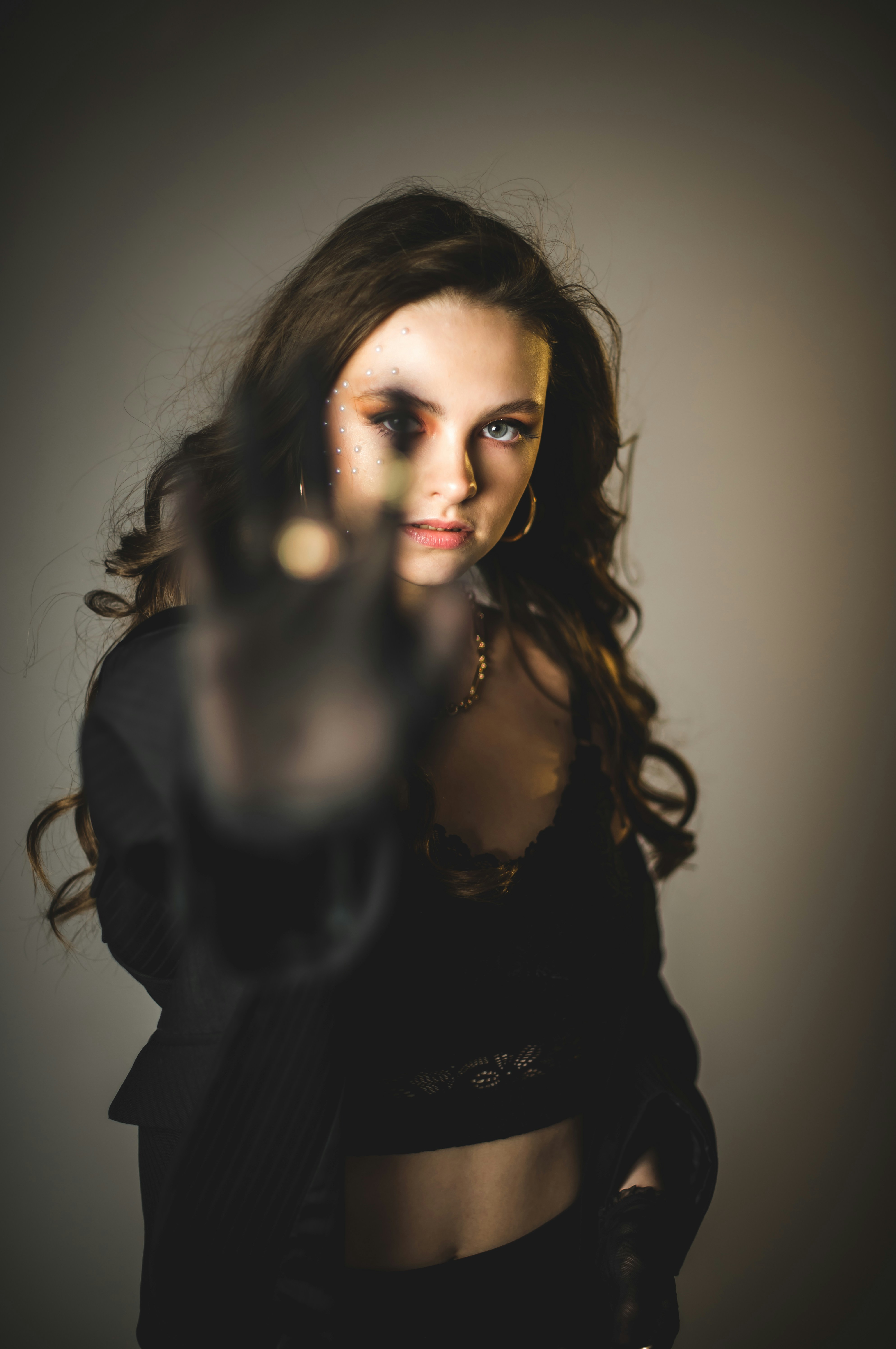 Direct Gaze Through a Reaching Gesture in a Low-Key Studio Portrait