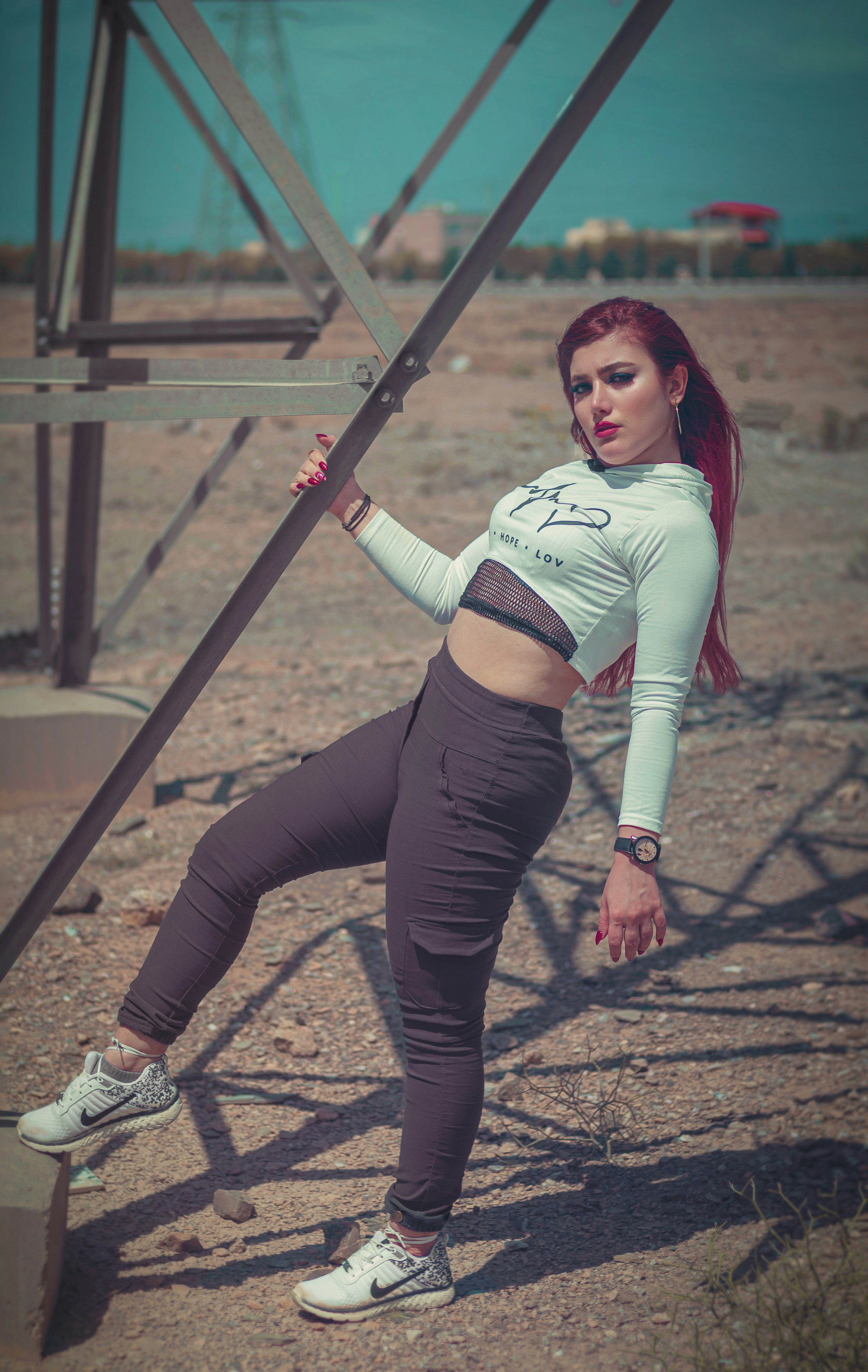 woman in white and red long sleeve shirt and black leggings holding black rifle
