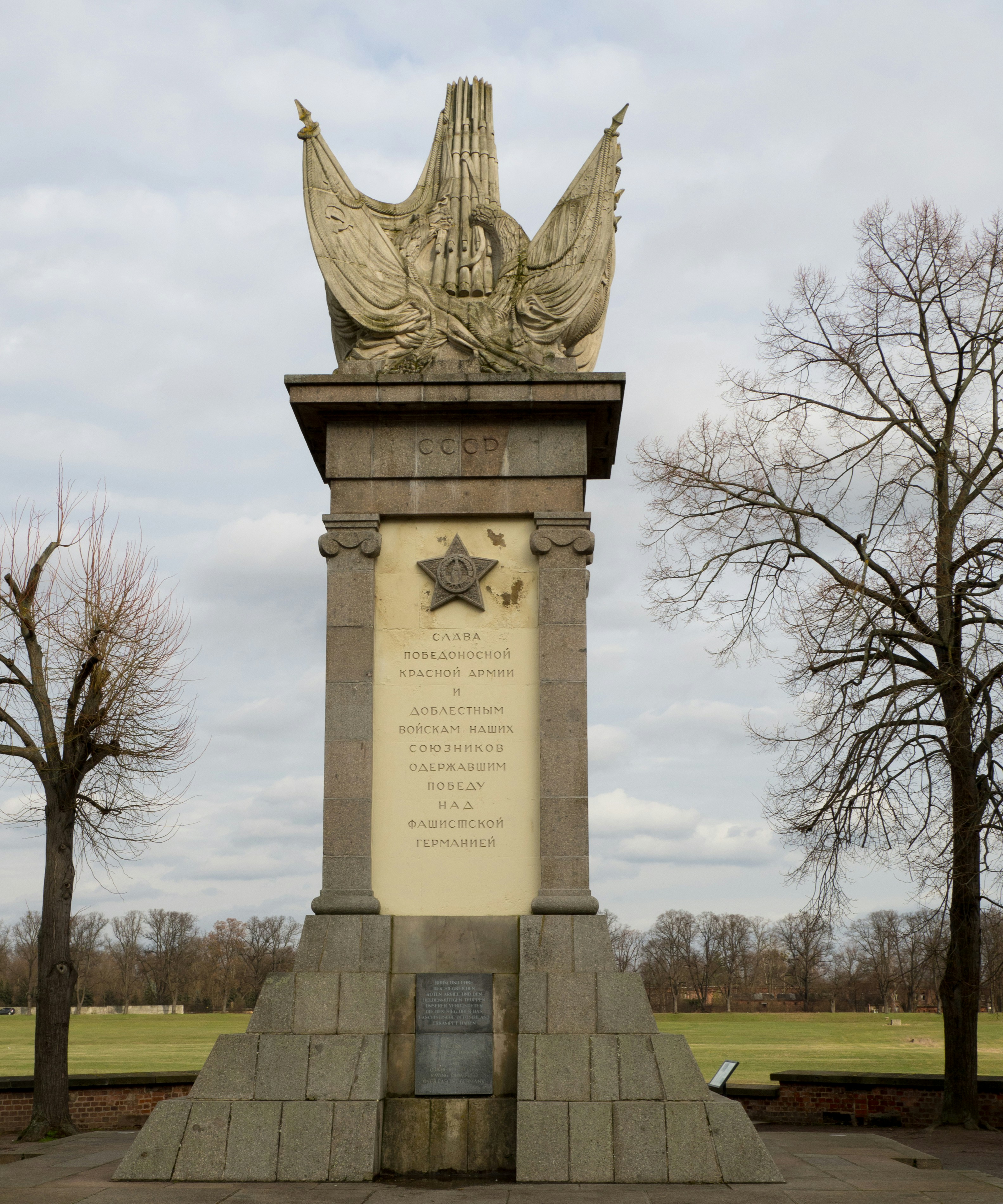 Winged Resolve: A Soviet Memorial Obelisk Rising in a Park