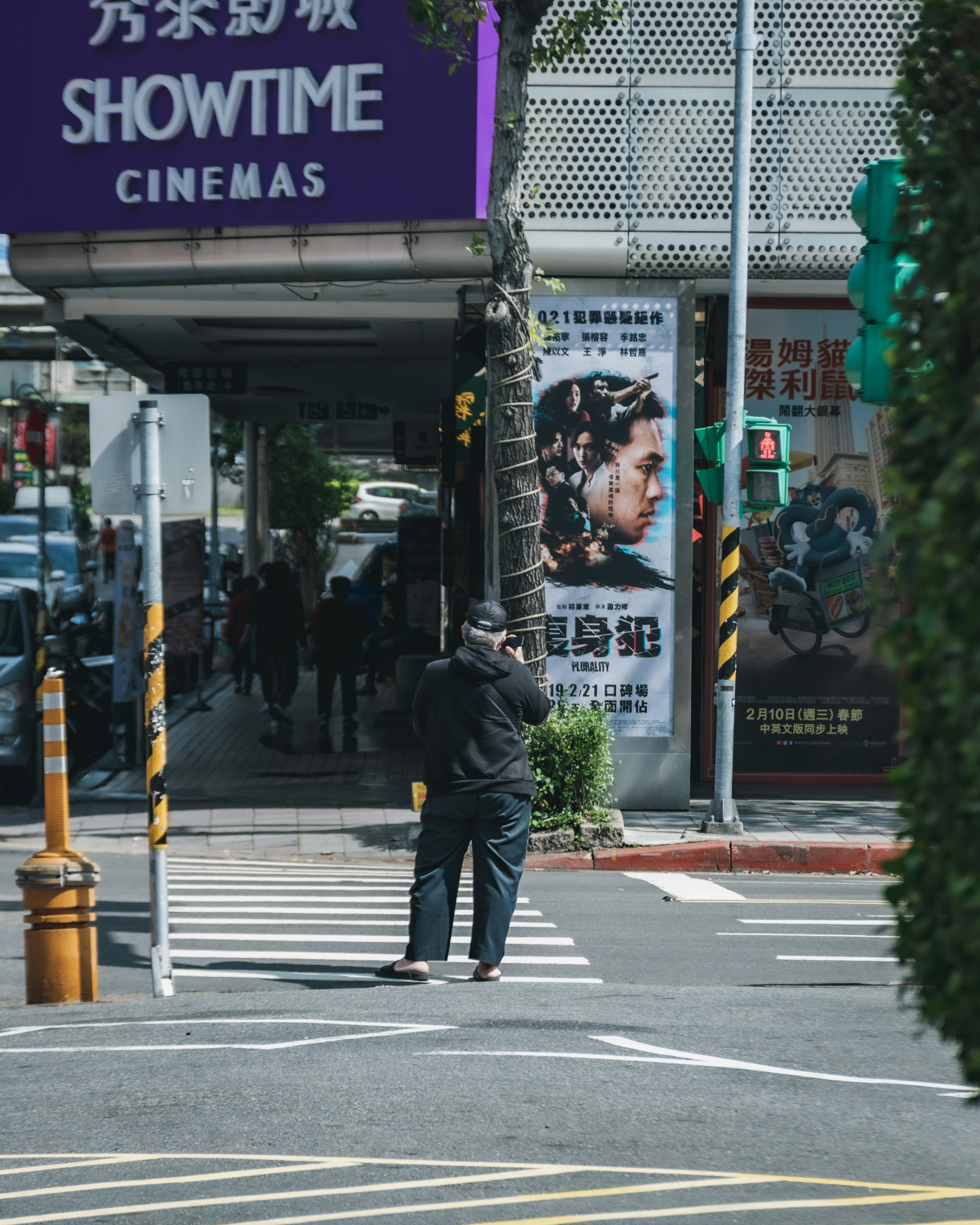 Crosswalk Portrait Under a Purple Showtime Cinemas Sign