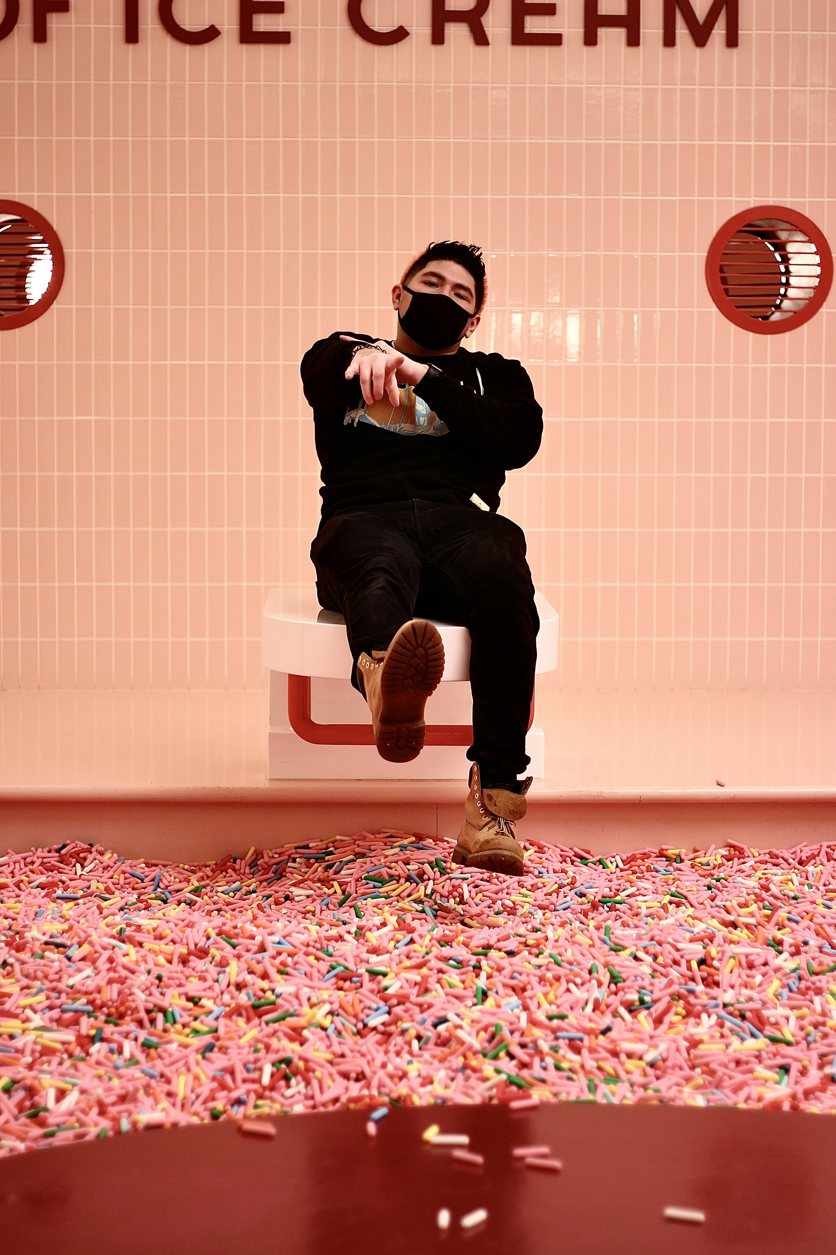 Sitting in the Pink: A Confident Moment Amid Rainbow Sprinkles