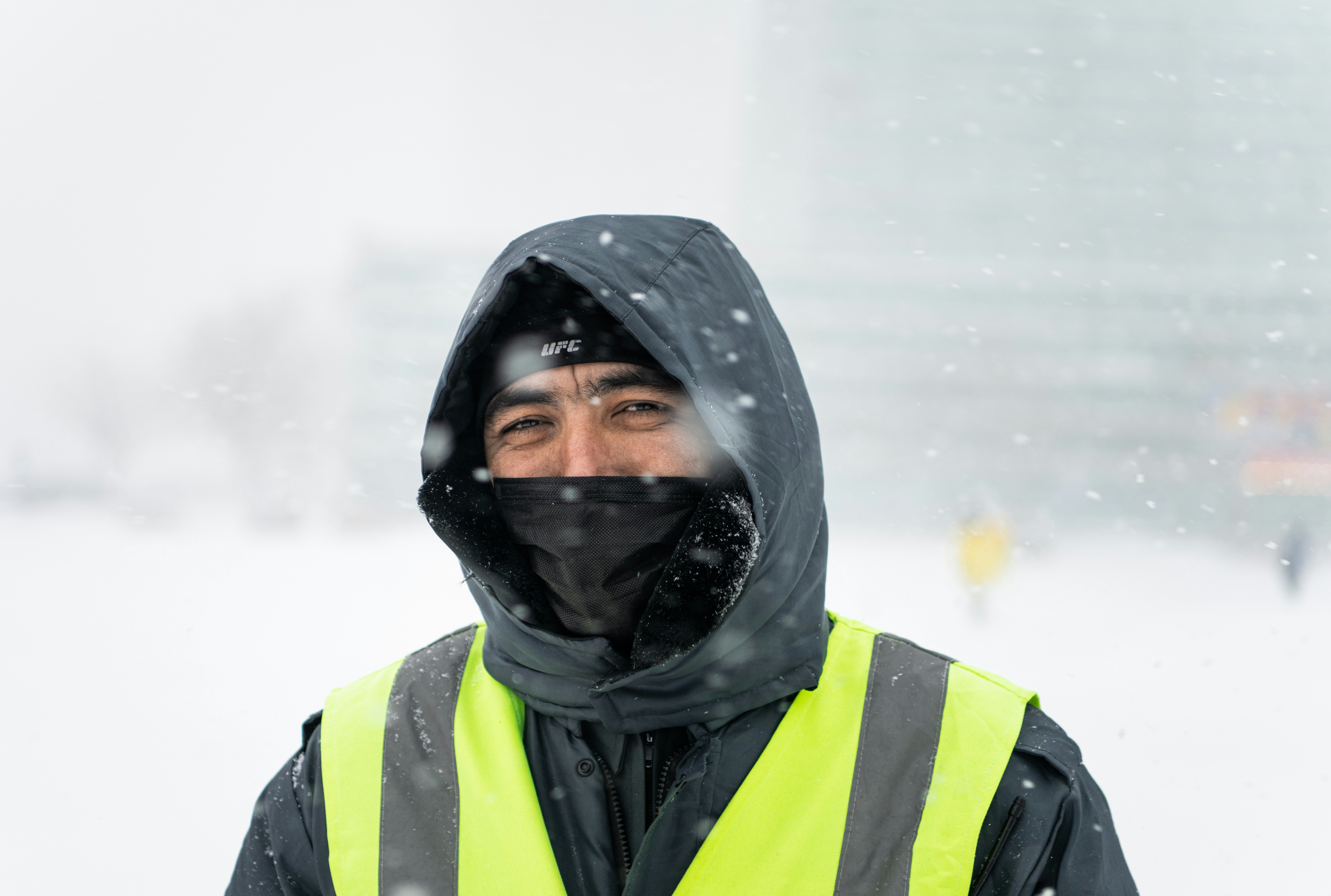 Snowbound Sentinel: A High-Visibility Worker Braving a Whiteout