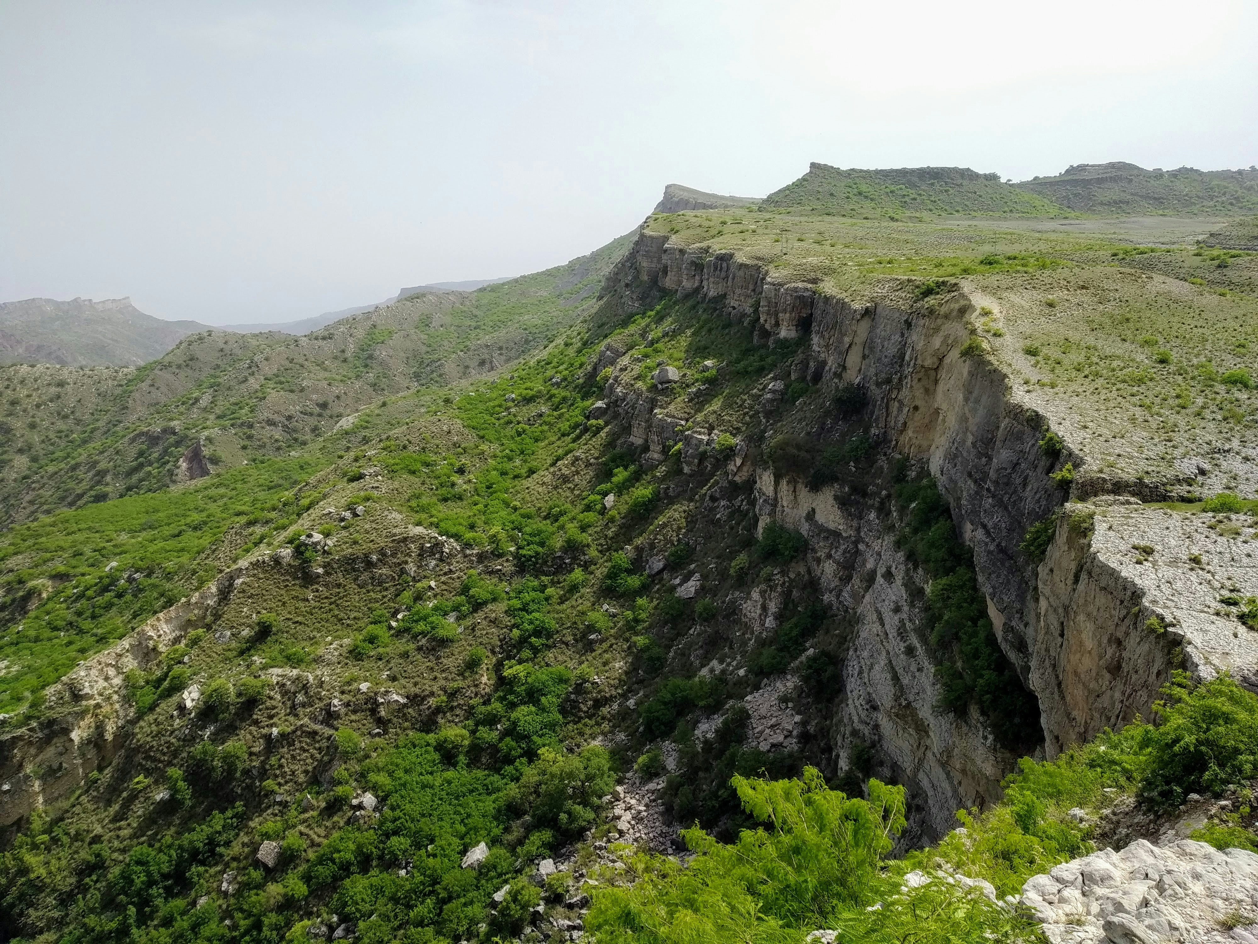 Green grass covered mountain under white sky during daytime photo ...