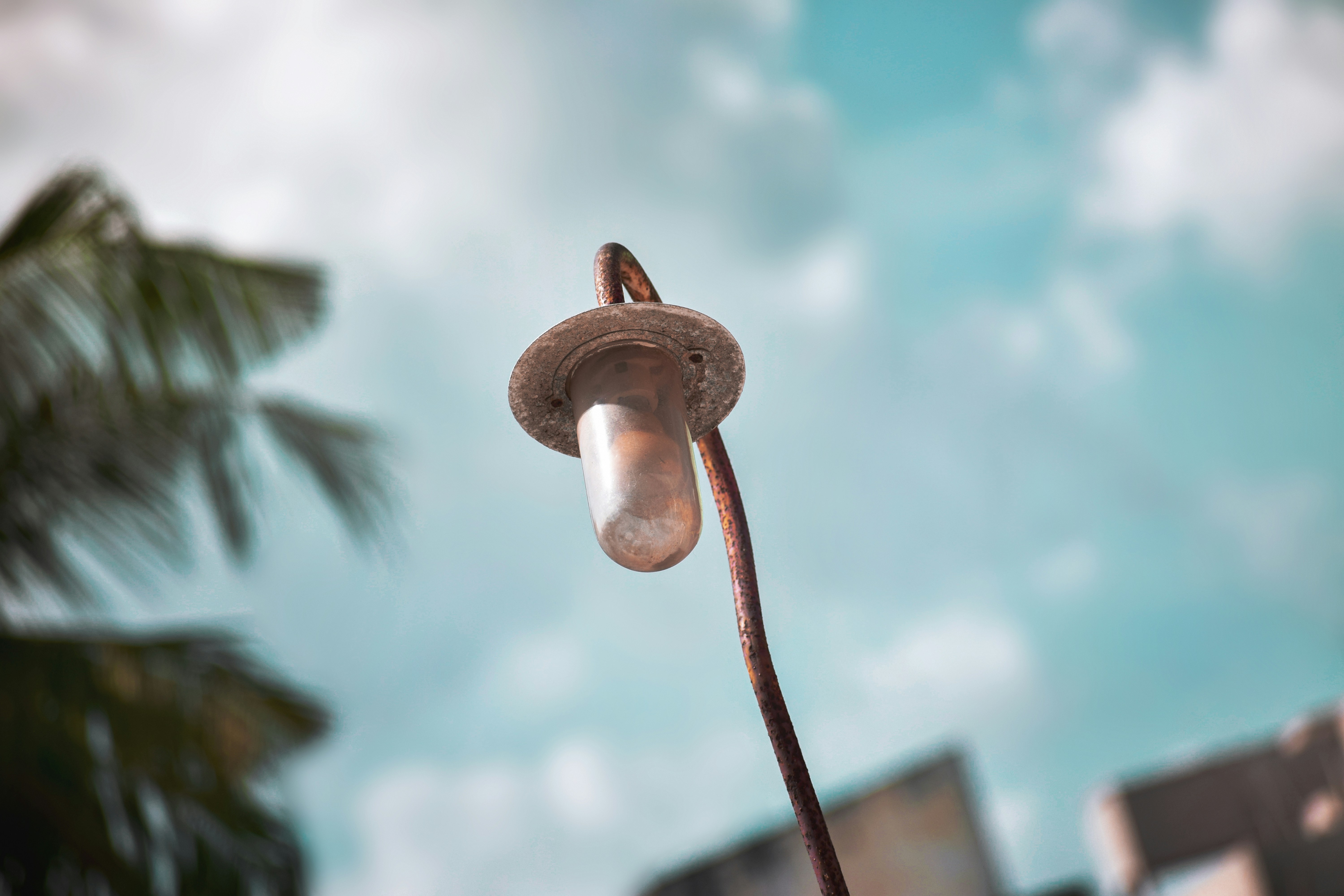 Close-Up of a Weathered Street Lamp Against a Caribbean Sky