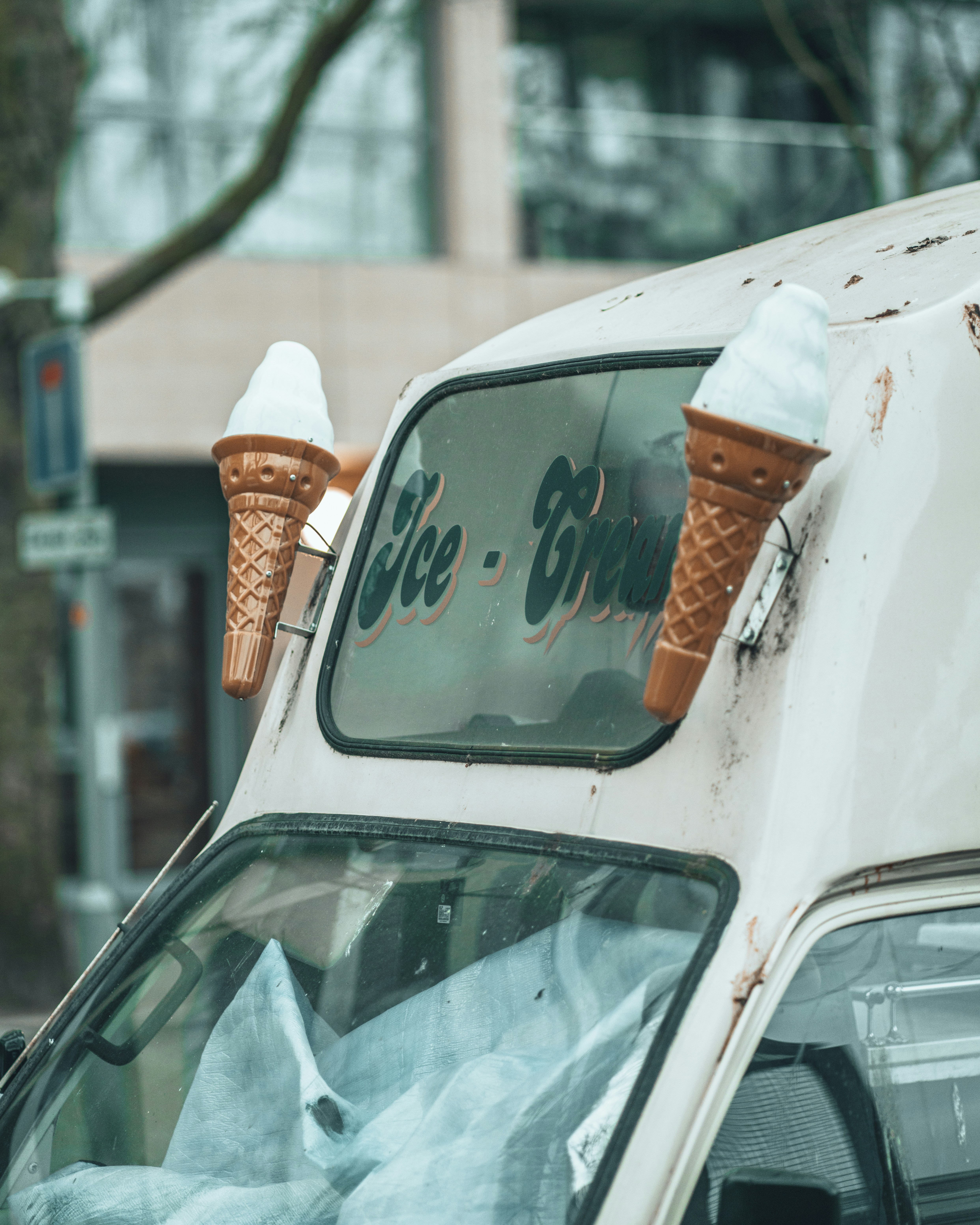 Cone-Topped Ice Cream Van Anchored in a Quiet City Street