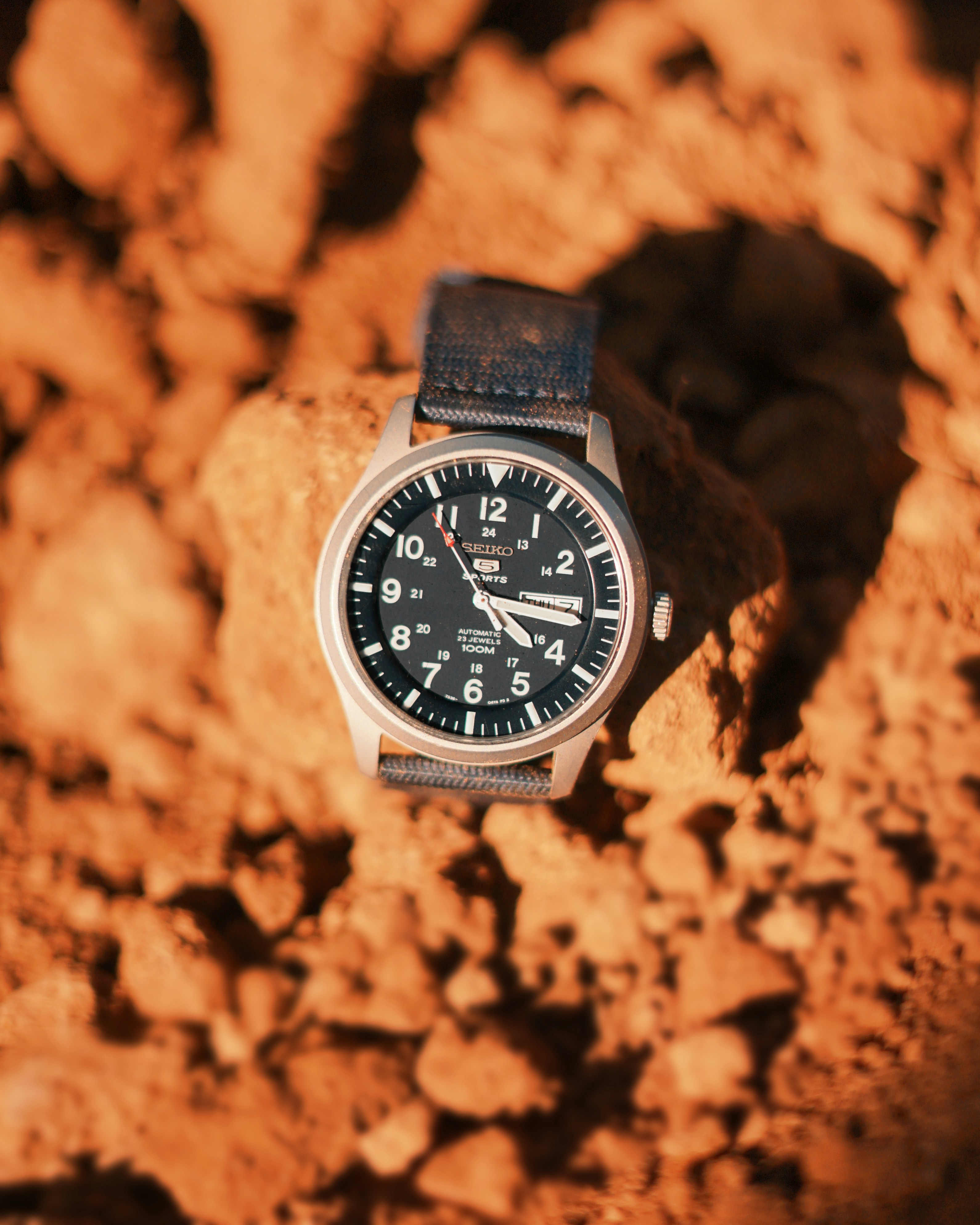 a watch sitting on top of a rock