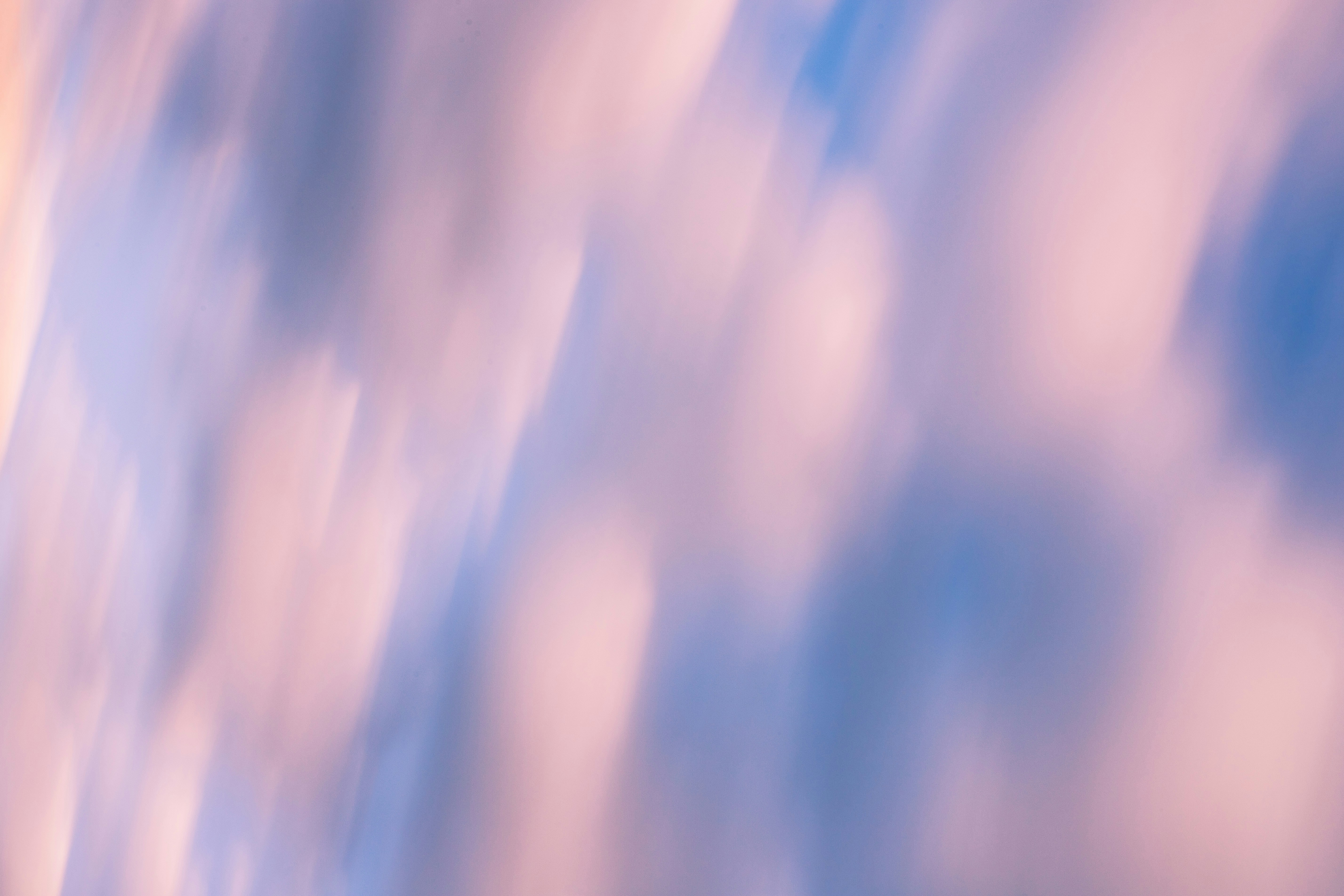 Softly blurred pink and blue clouds creating a dreamy, abstract effect.