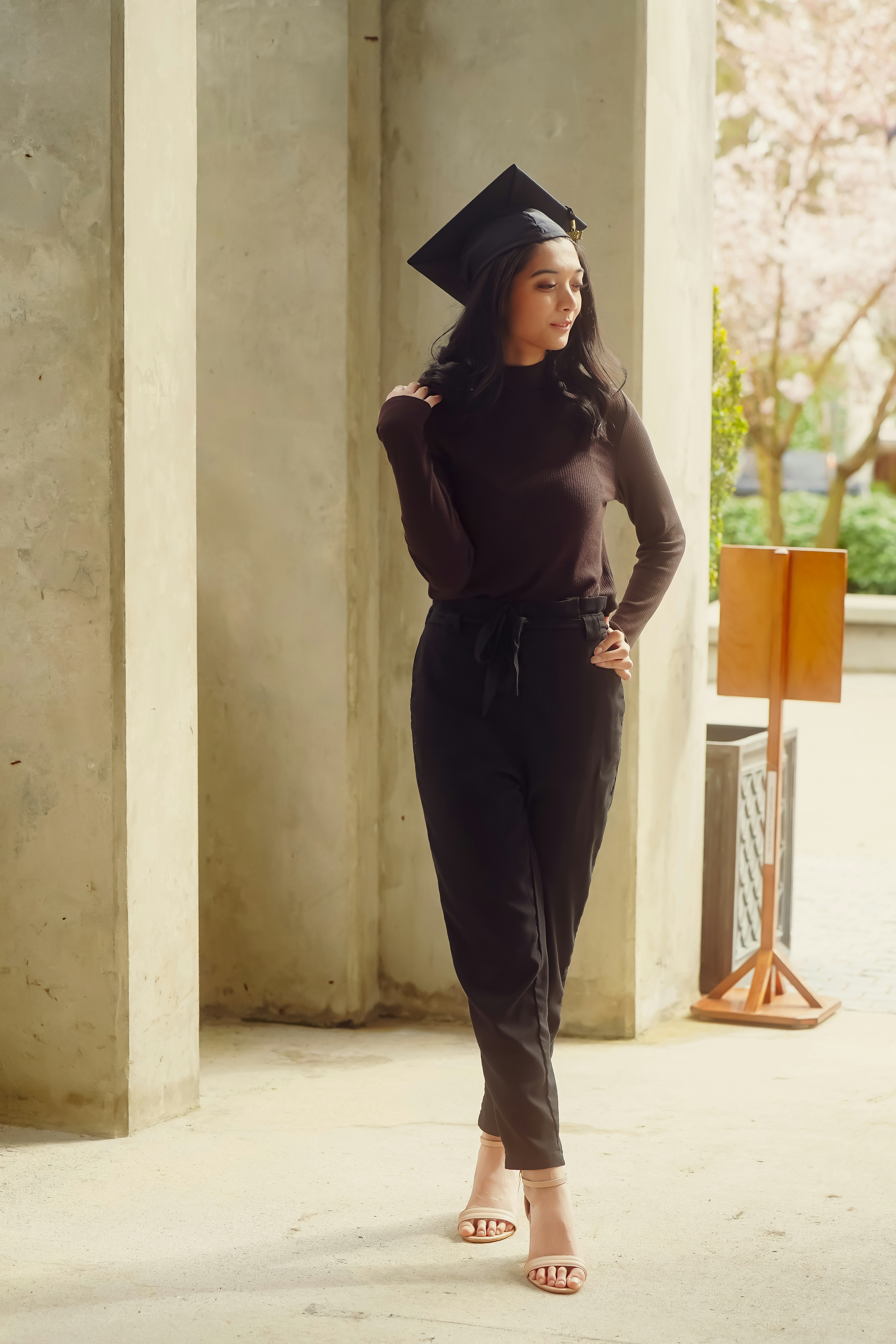 Between Columns, a Graduate in Black Stands Tall