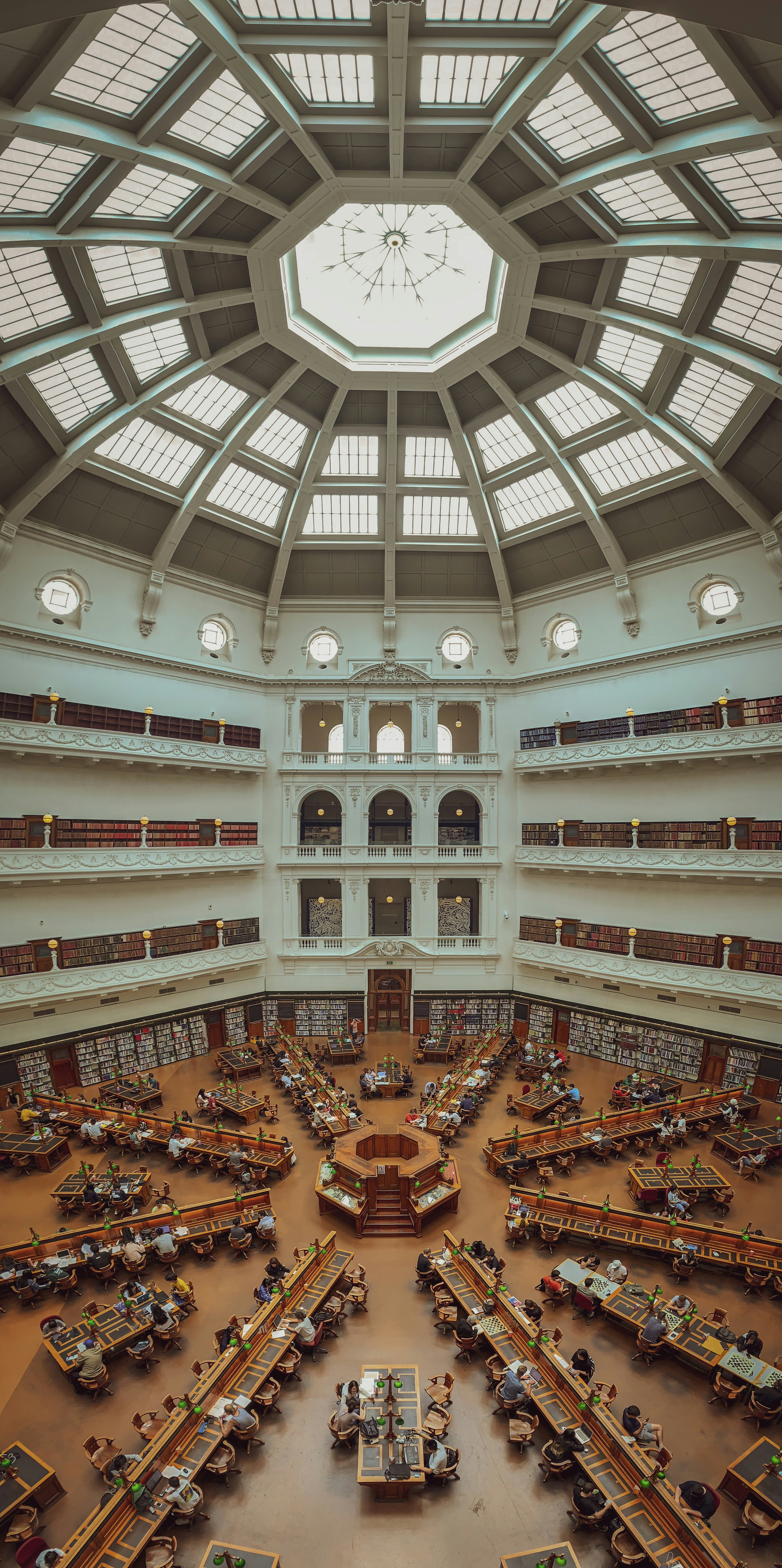 People walking inside building with lights turned on during daytime ...