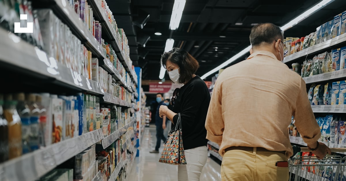 Man In Brown Long Sleeve Shirt And Brown Pants Standing Beside Woman In