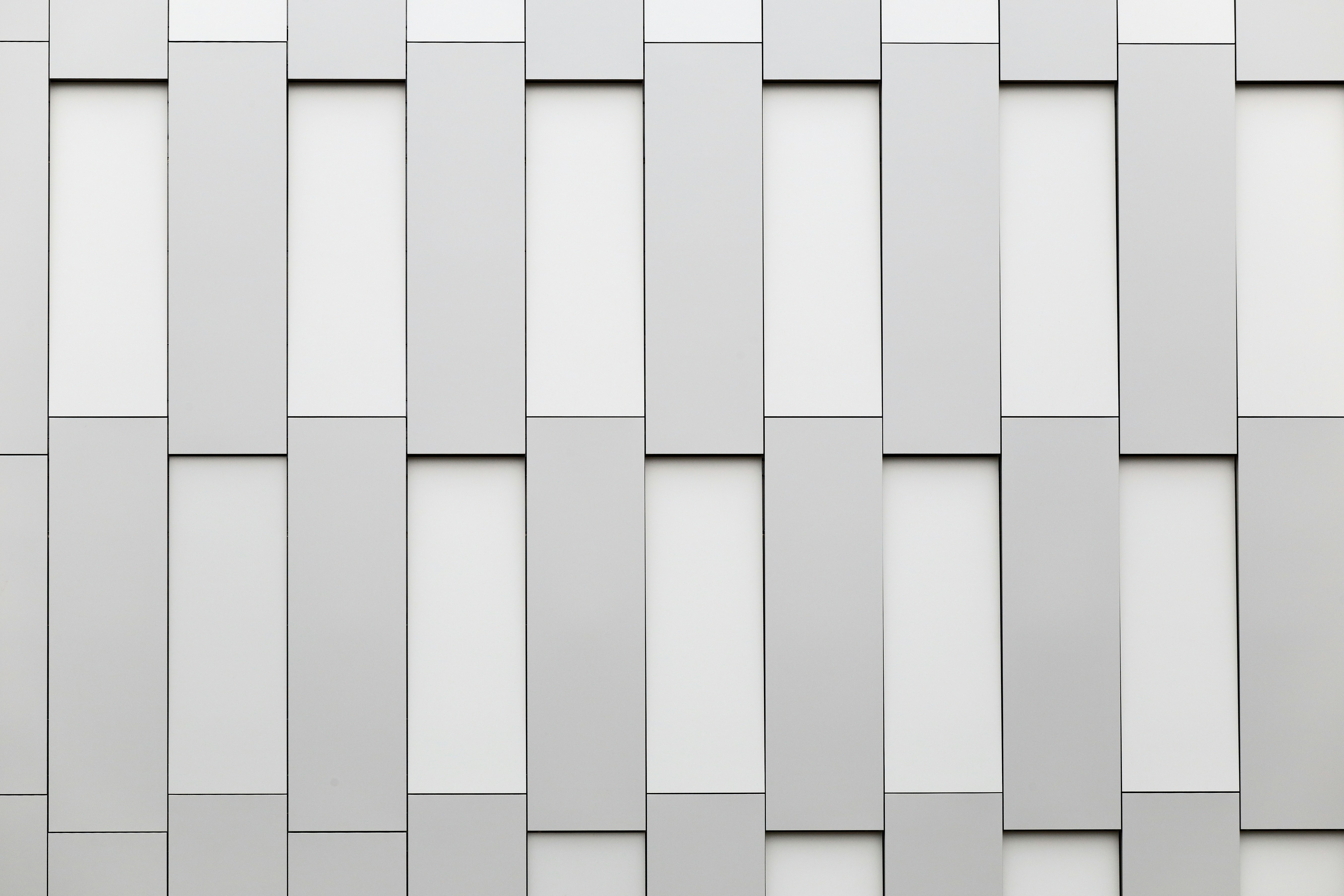 Vertical Geometry: Repeating Slabs on a Pale Facade