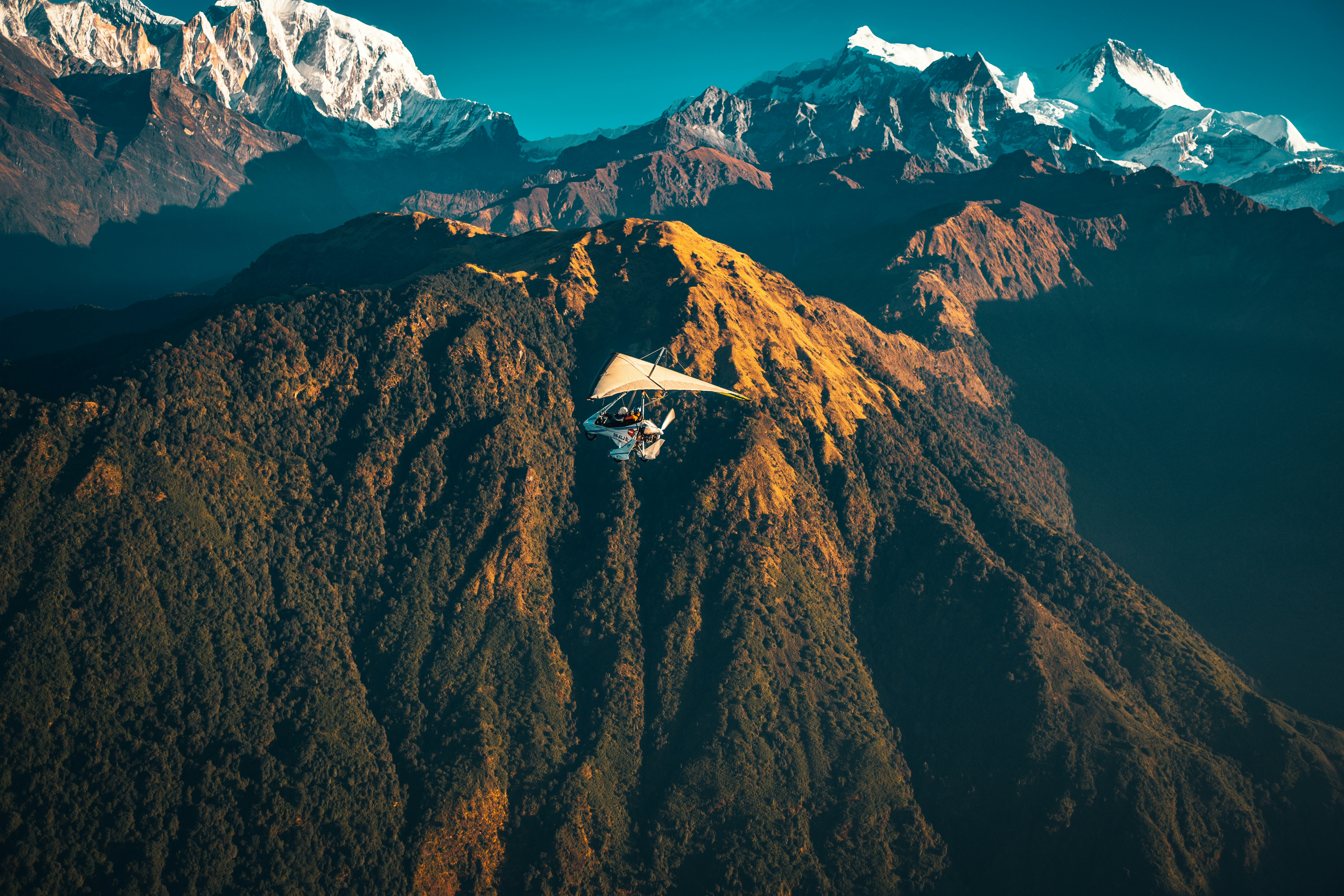 Lightweight aircraft above valley Himalayn mountain near Machapuchare Mardi Himal track in the Himalaya mountains