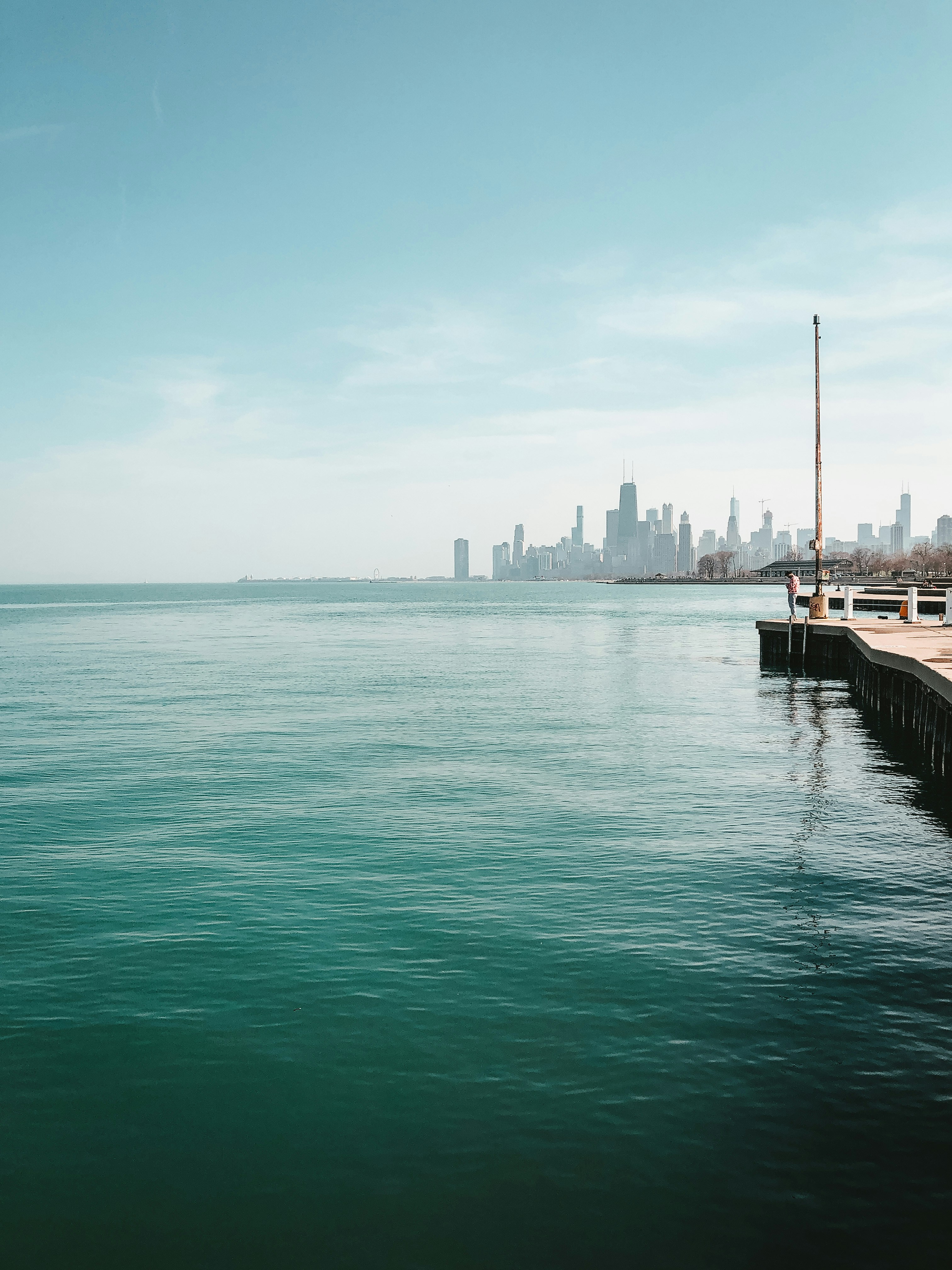 Cityline on the Horizon: Quiet Pier by a Distant Skyline